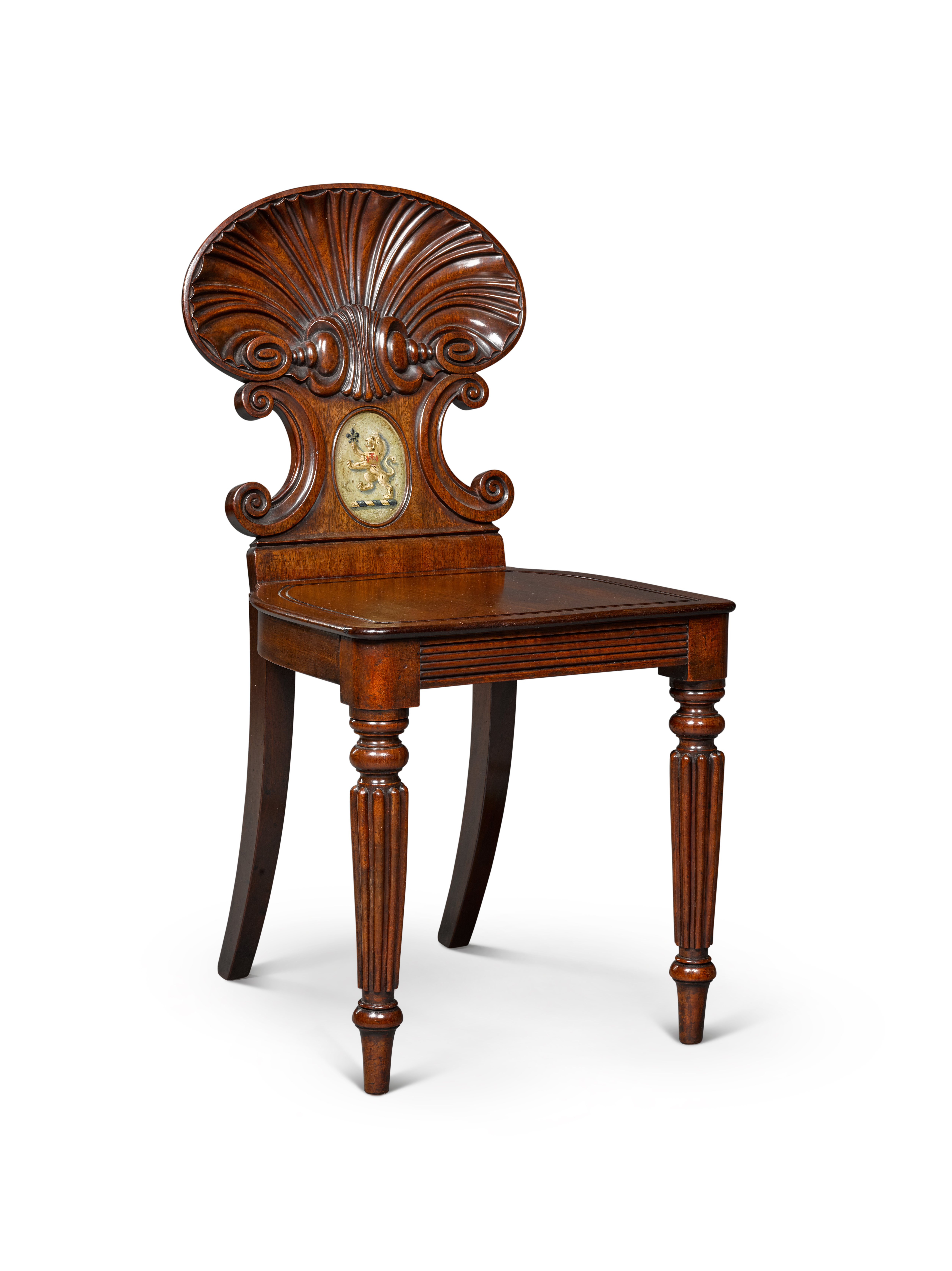 A pair of late Regency mahogany hall chairs, circa 1825, attributed to ...