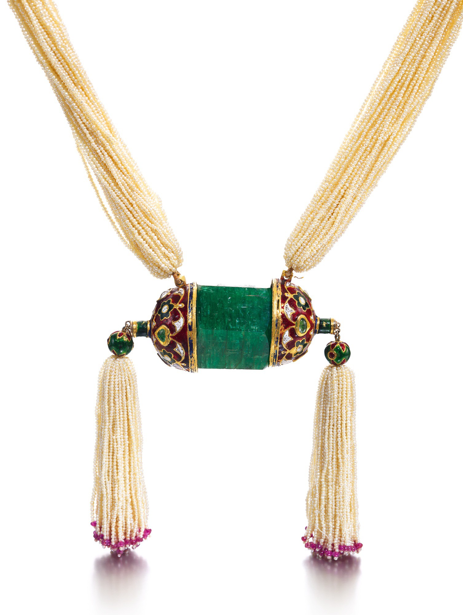 A MUGHAL EMERALD CRYSTAL SET IN ENAMELLED MOUNT WITH SEED-PEARL STRING ...