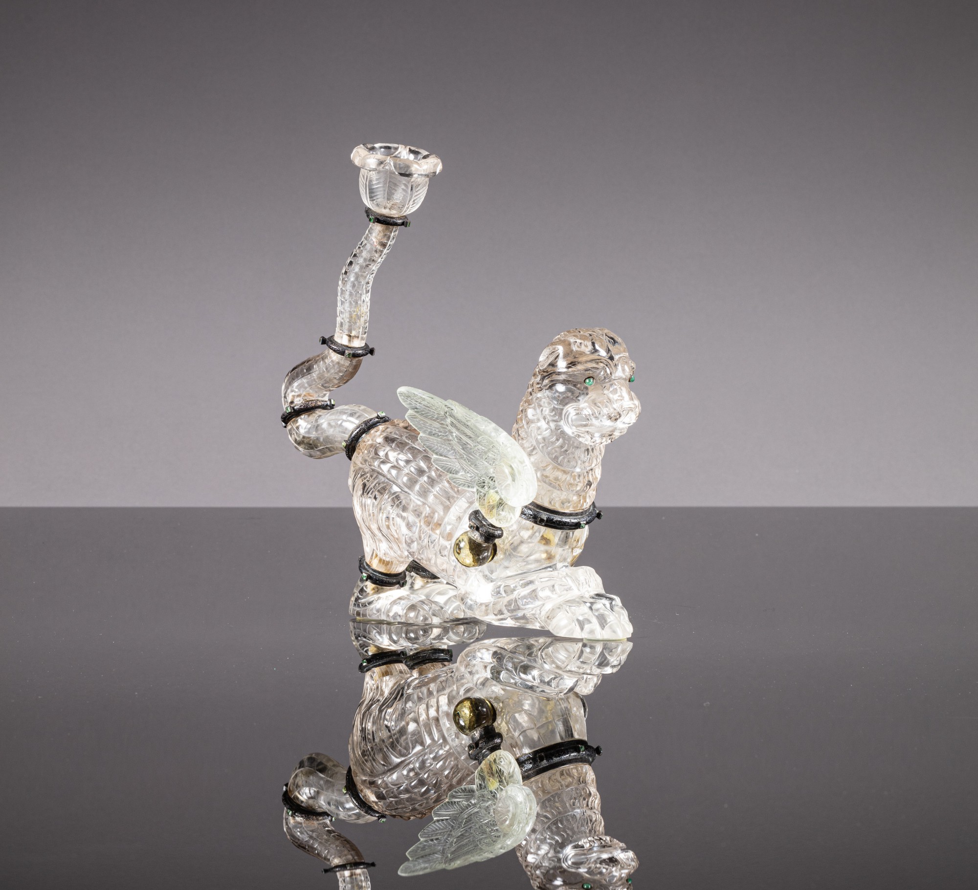 An Austrian rock crystal and enamel chimera with emerald cabochons and ...