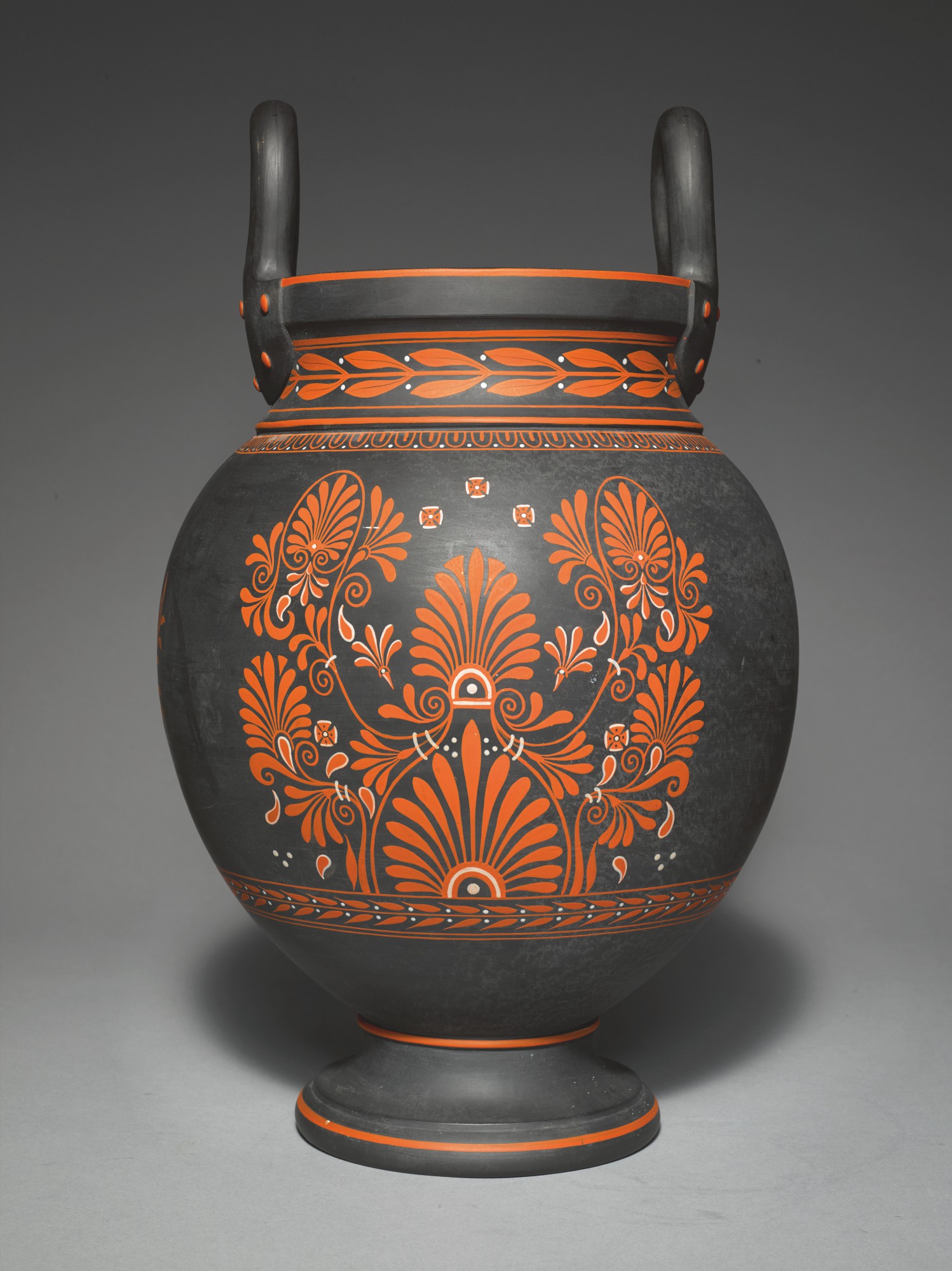 A WEDGWOOD BLACK BASALT 'ENCAUSTIC'-DECORATED TWO-HANDLED VASE, COVER ...