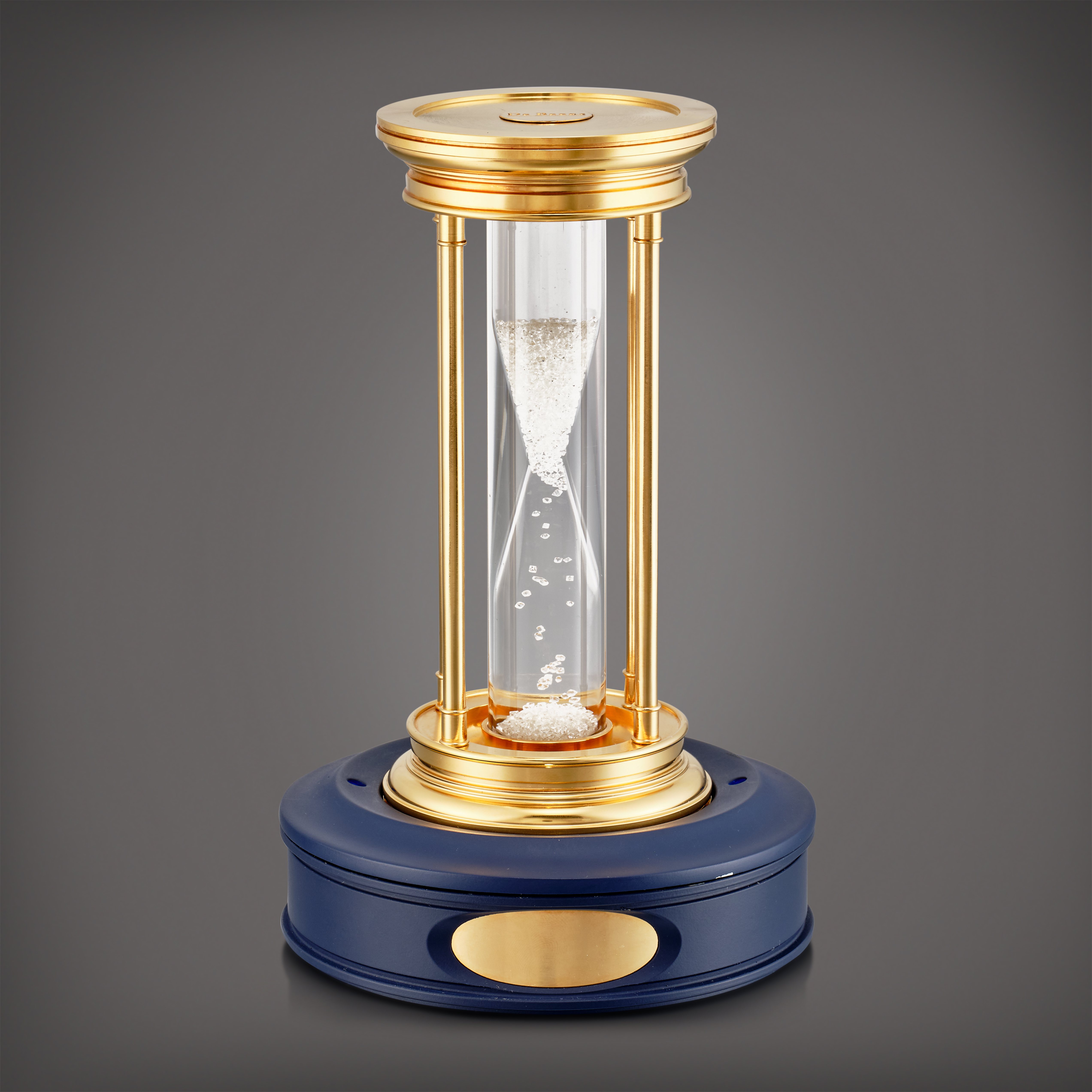 A limited edition gilt brass hourglass with floating diamonds, Circa ...
