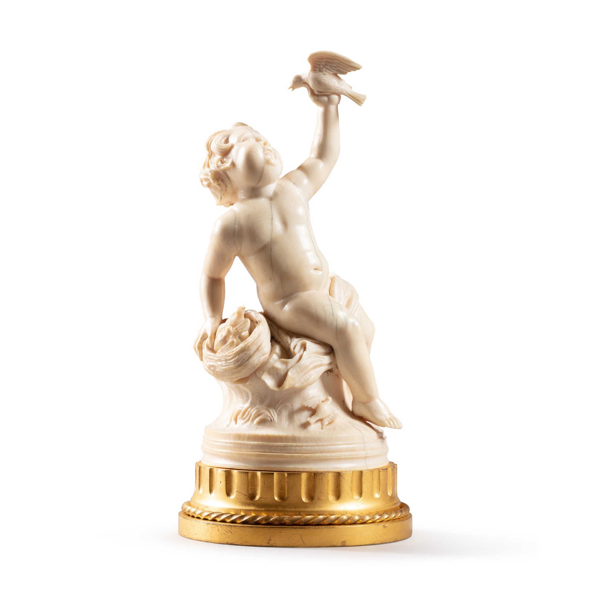 A French ivory seated Putto holding a bird, Late 18th / early 19th ...