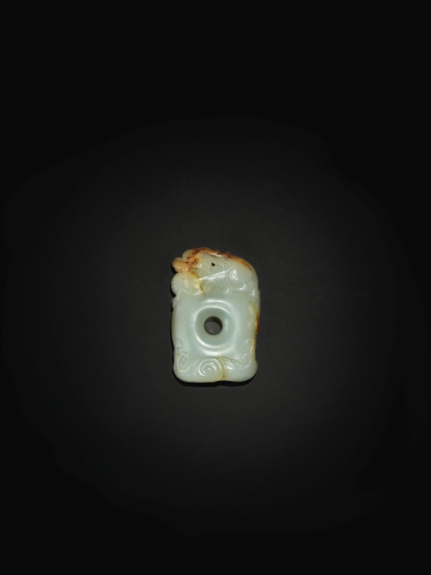 A FINE AND RARE WHITE AND RUSSET JADE 'QILIN' PENDANT, QING DYNASTY ...