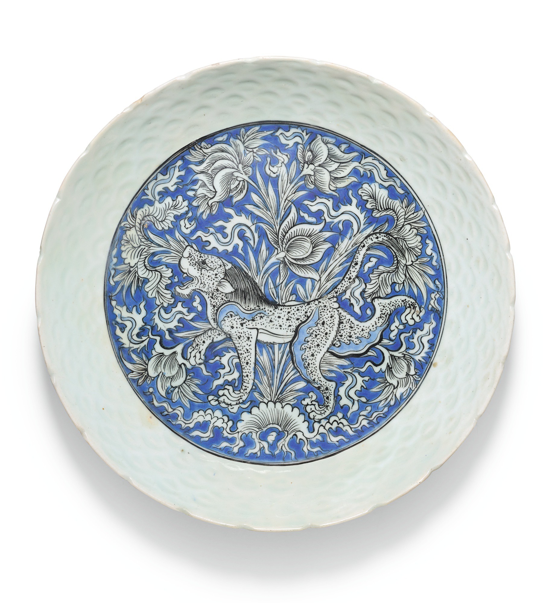 A SAFAVID BLUE AND WHITE POTTERY DISH DEPICTING A LION, PERSIA, 17TH ...