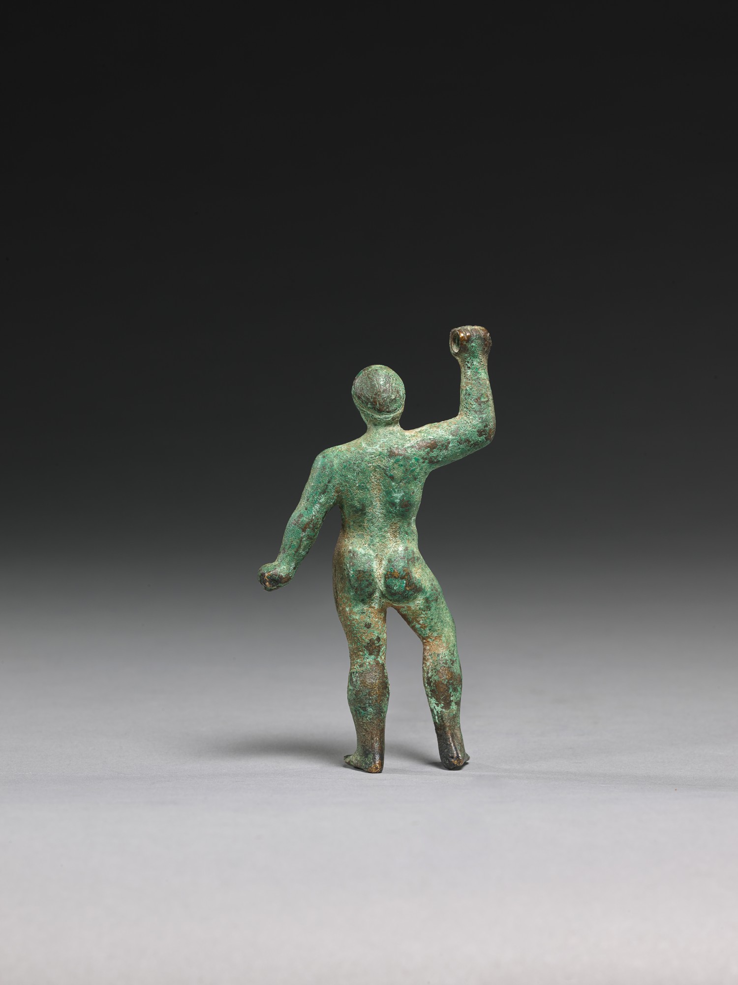 A GREEK BRONZE FIGURE OF A KOUROS, 2ND HALF OF THE 6TH CENTURY B.C ...