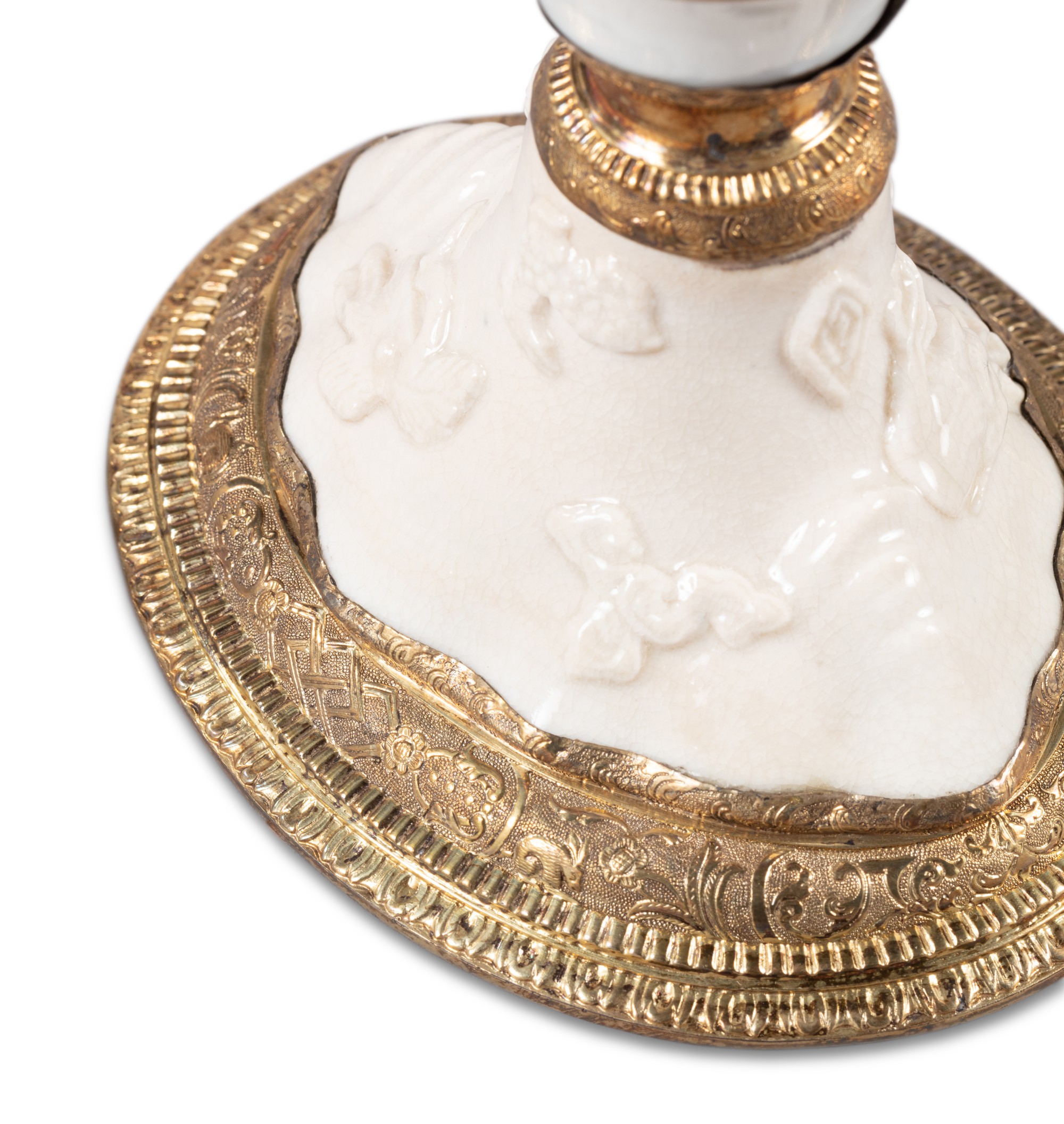 A pair of silver-mounted blanc de Chine porcelain candlesticks, the ...