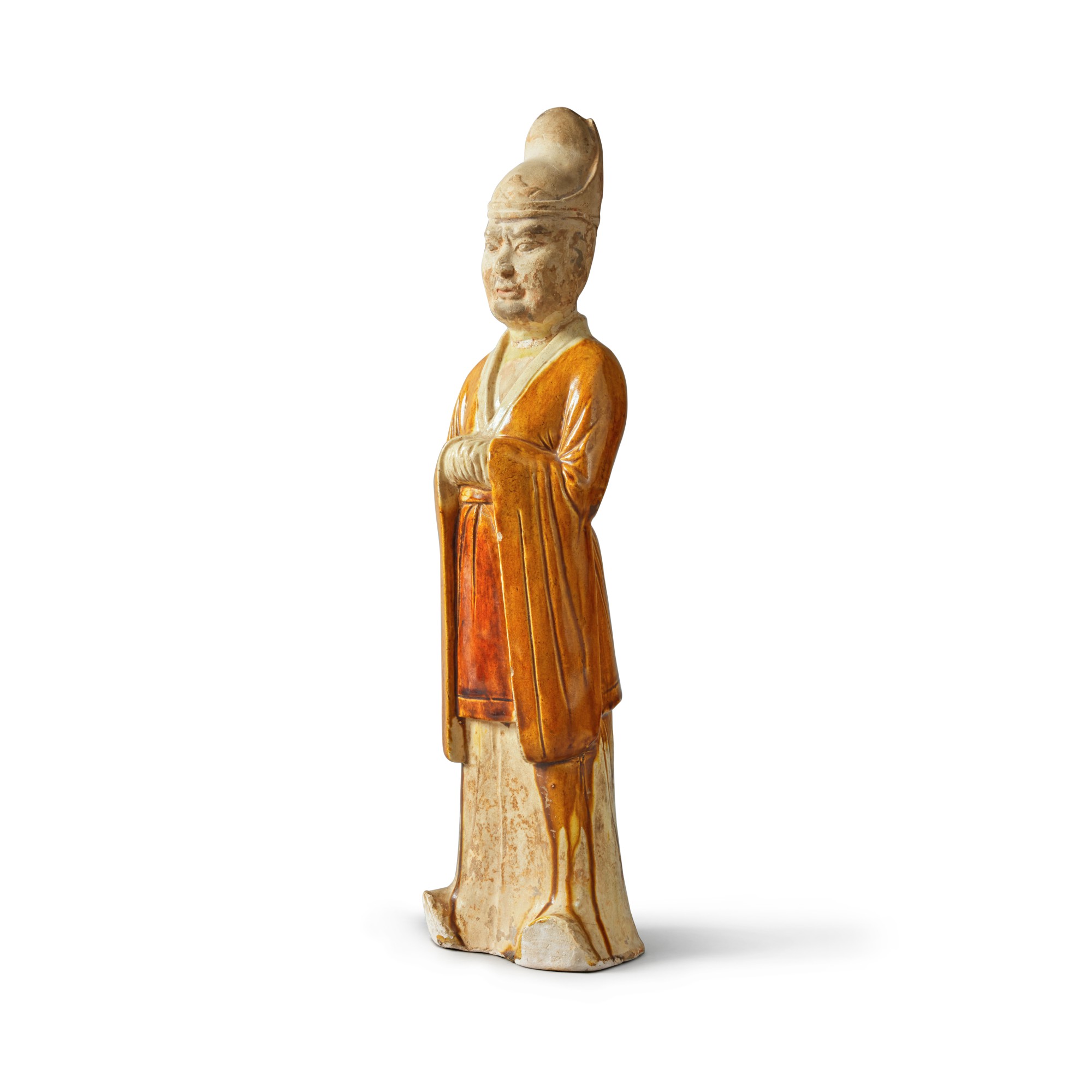 A straw- and amber-glazed pottery figure of an official, Tang dynasty ...