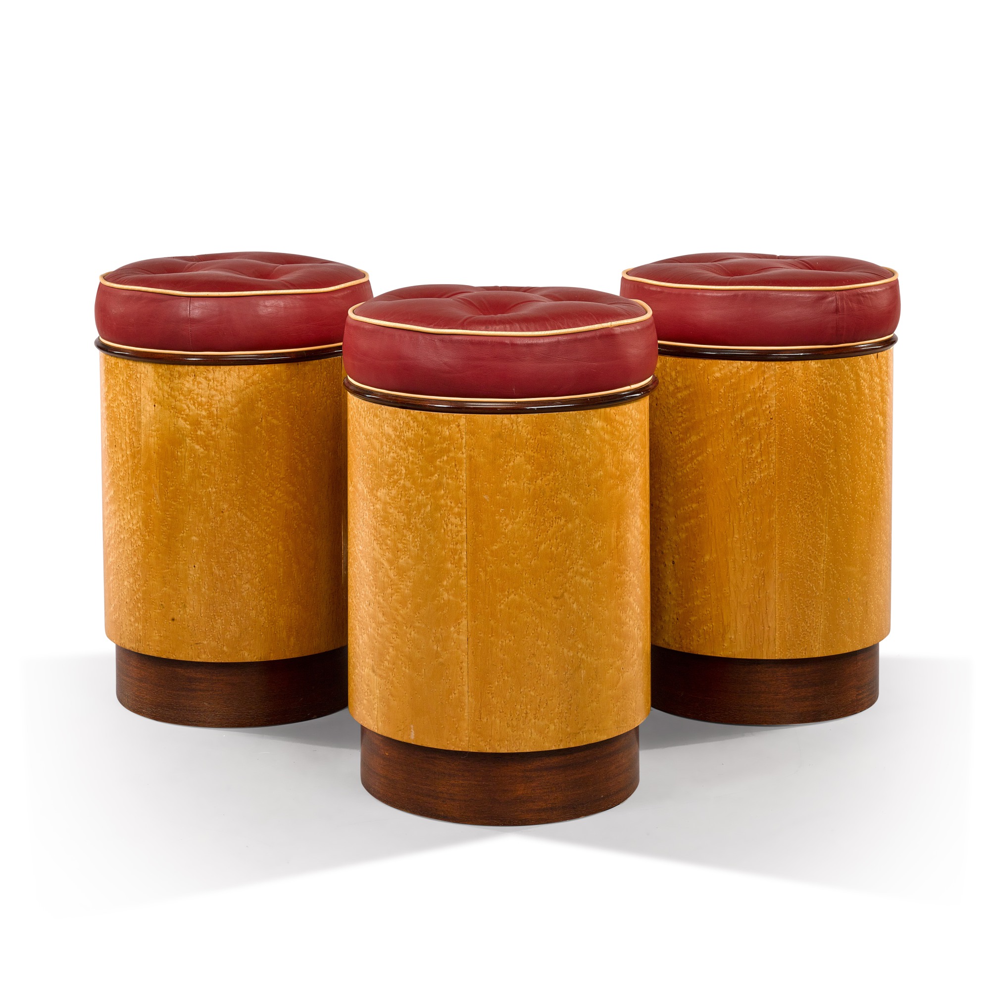 A set of three of bird's eye maple and mahogany stools designed by ...