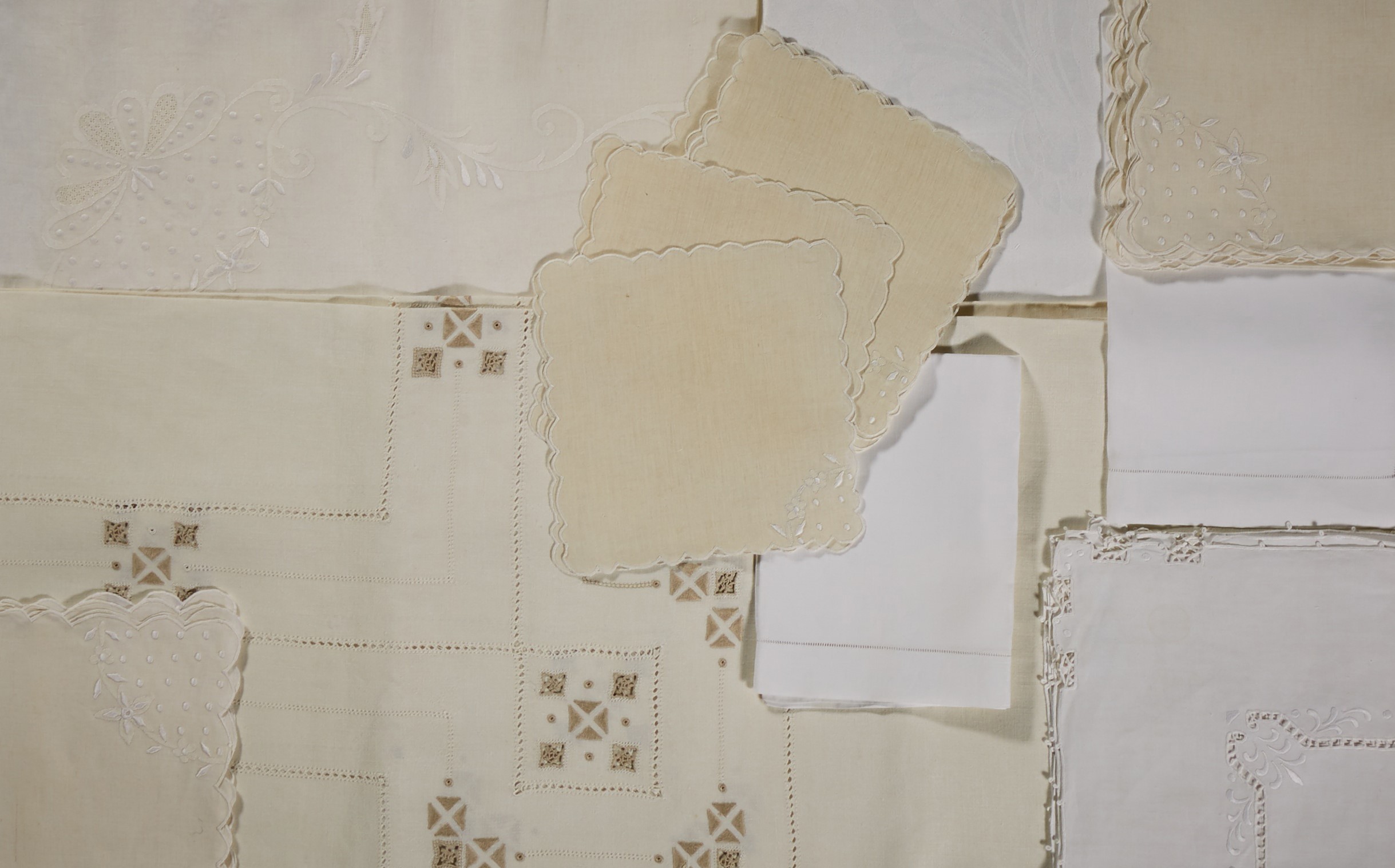 A collection of domestic table linen, including napkins, table mats and ...