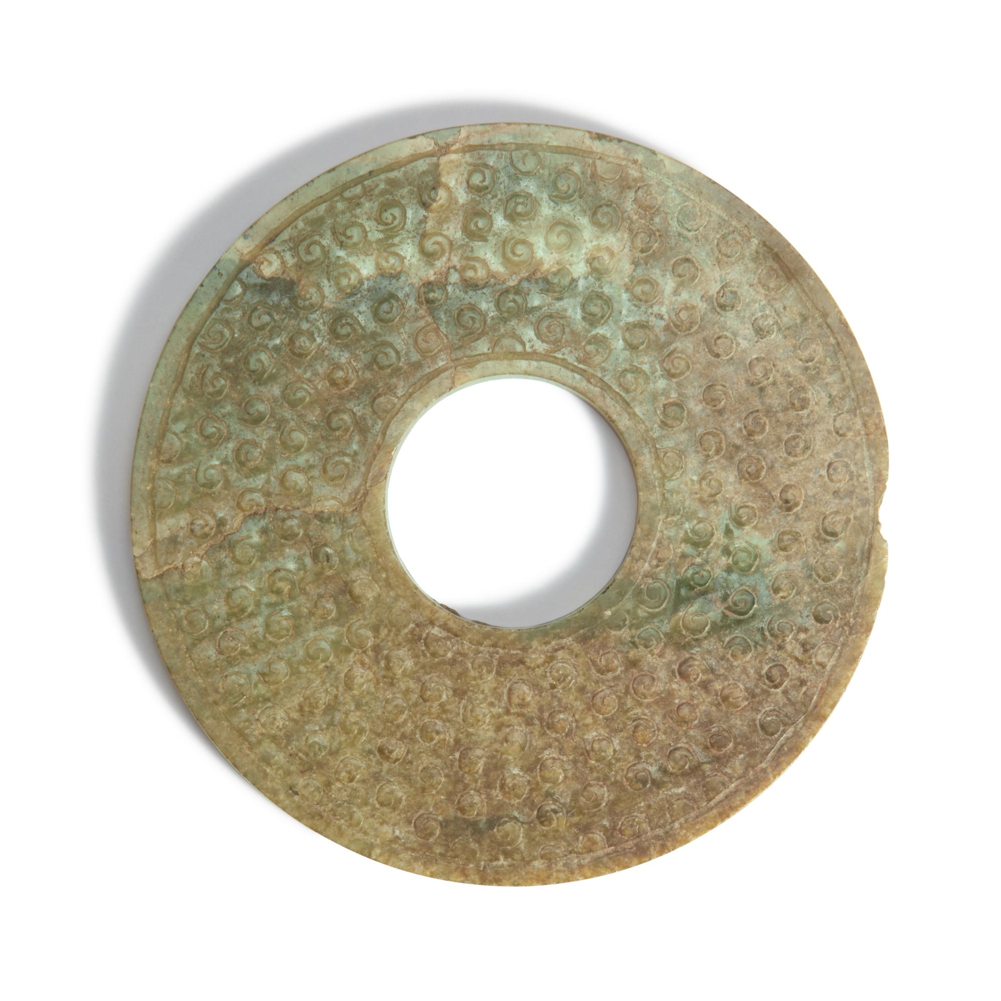 A green and russet jade bi disc, Warring States period / Western Han ...