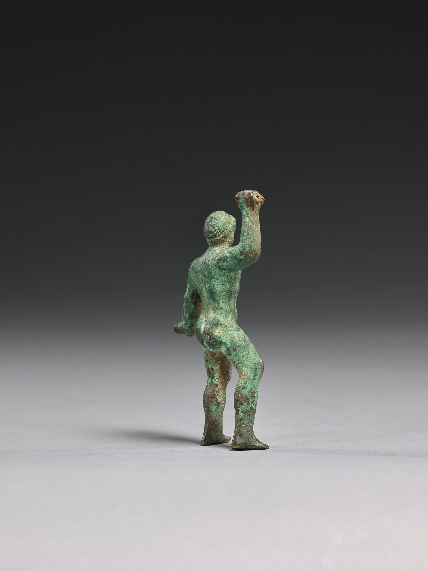 A GREEK BRONZE FIGURE OF A KOUROS, 2ND HALF OF THE 6TH CENTURY B.C ...