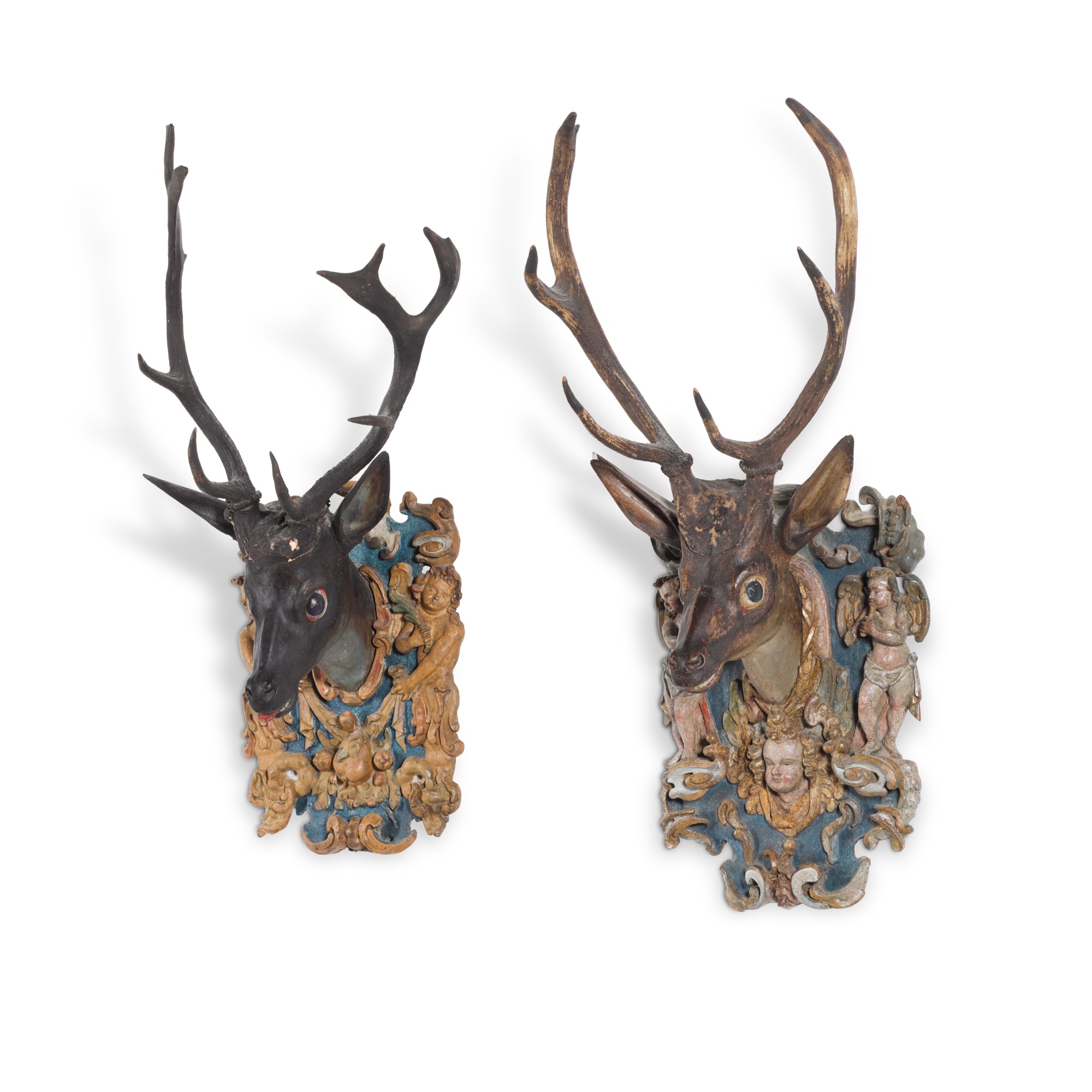 A pair of Continental carved and painted stags heads, probably German ...