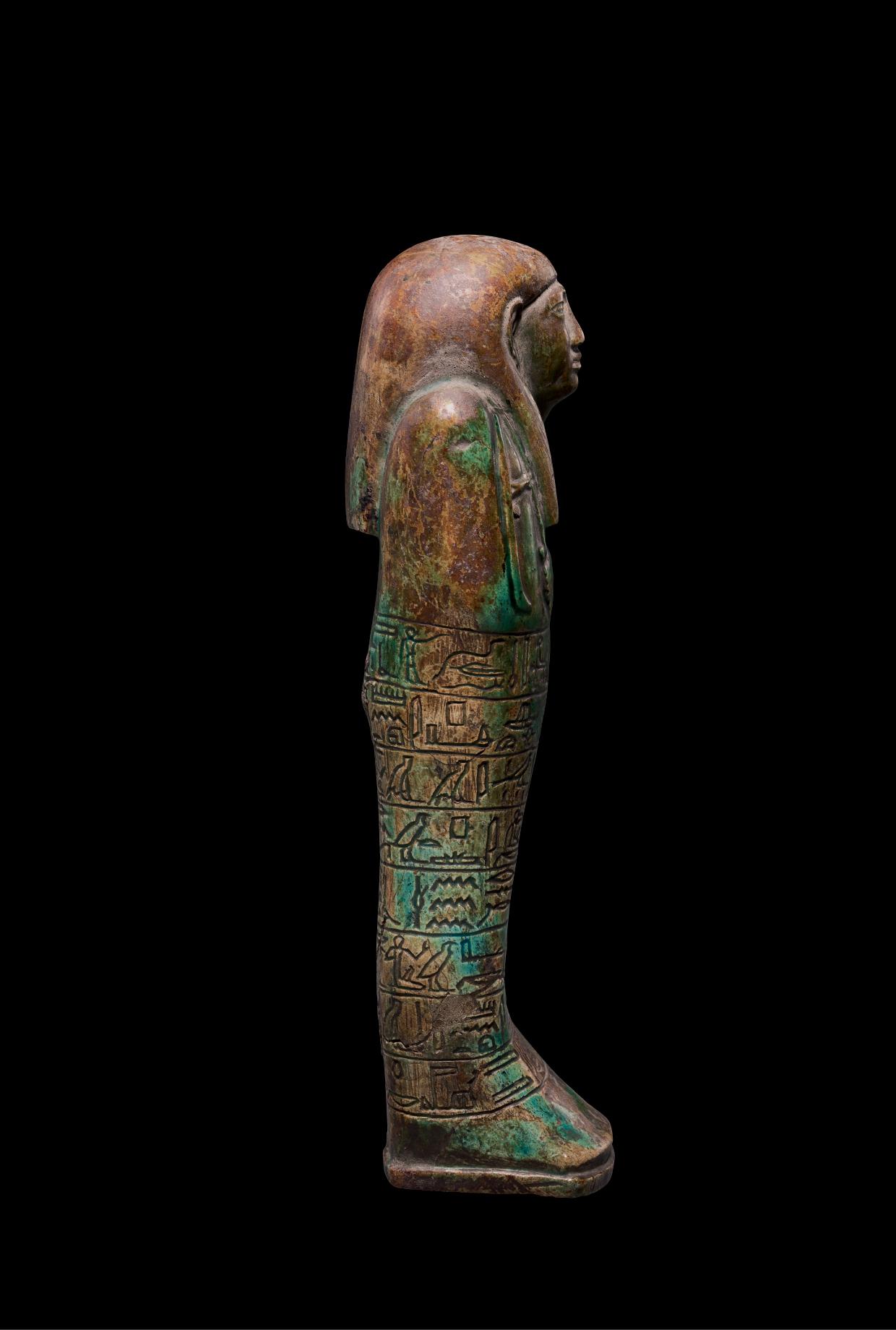AN EGYPTIAN BLUE-GREEN GLAZED STEATITE USHABTI OF THE CHIEF LECTOR ...
