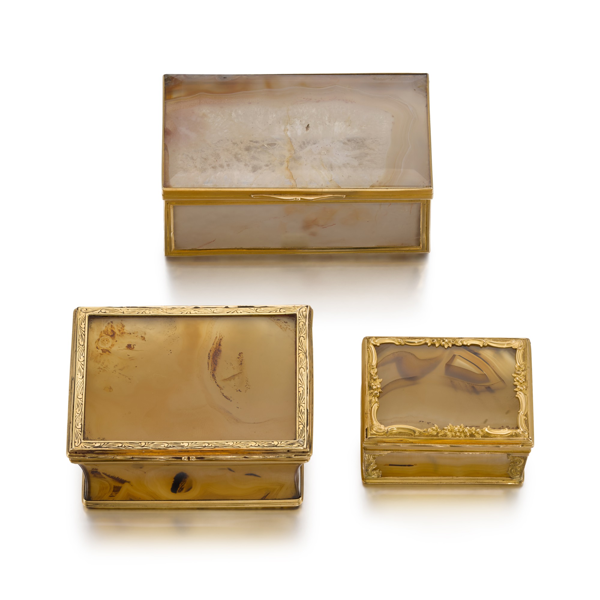 A group of three agate snuff boxes with gold cagework mounts, various ...