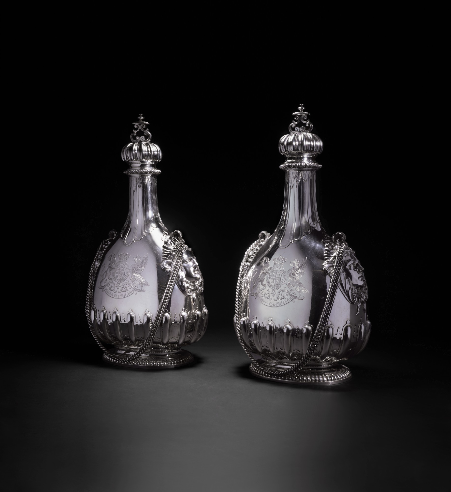 A matched pair of massive Victorian silver pilgrim bottles and covers ...