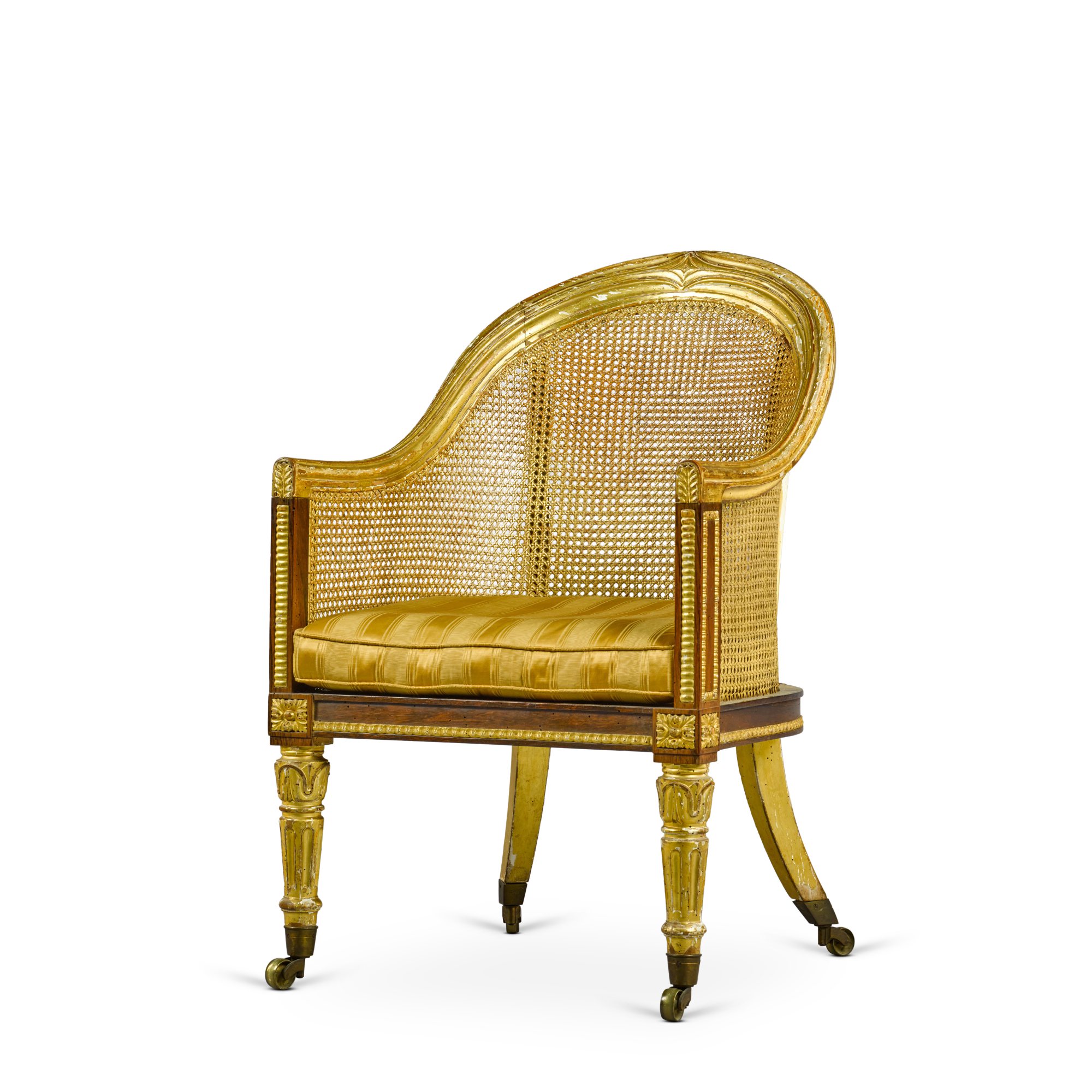 A pair of Regency simulated rosewood and parcel-gilt caned tub chairs ...