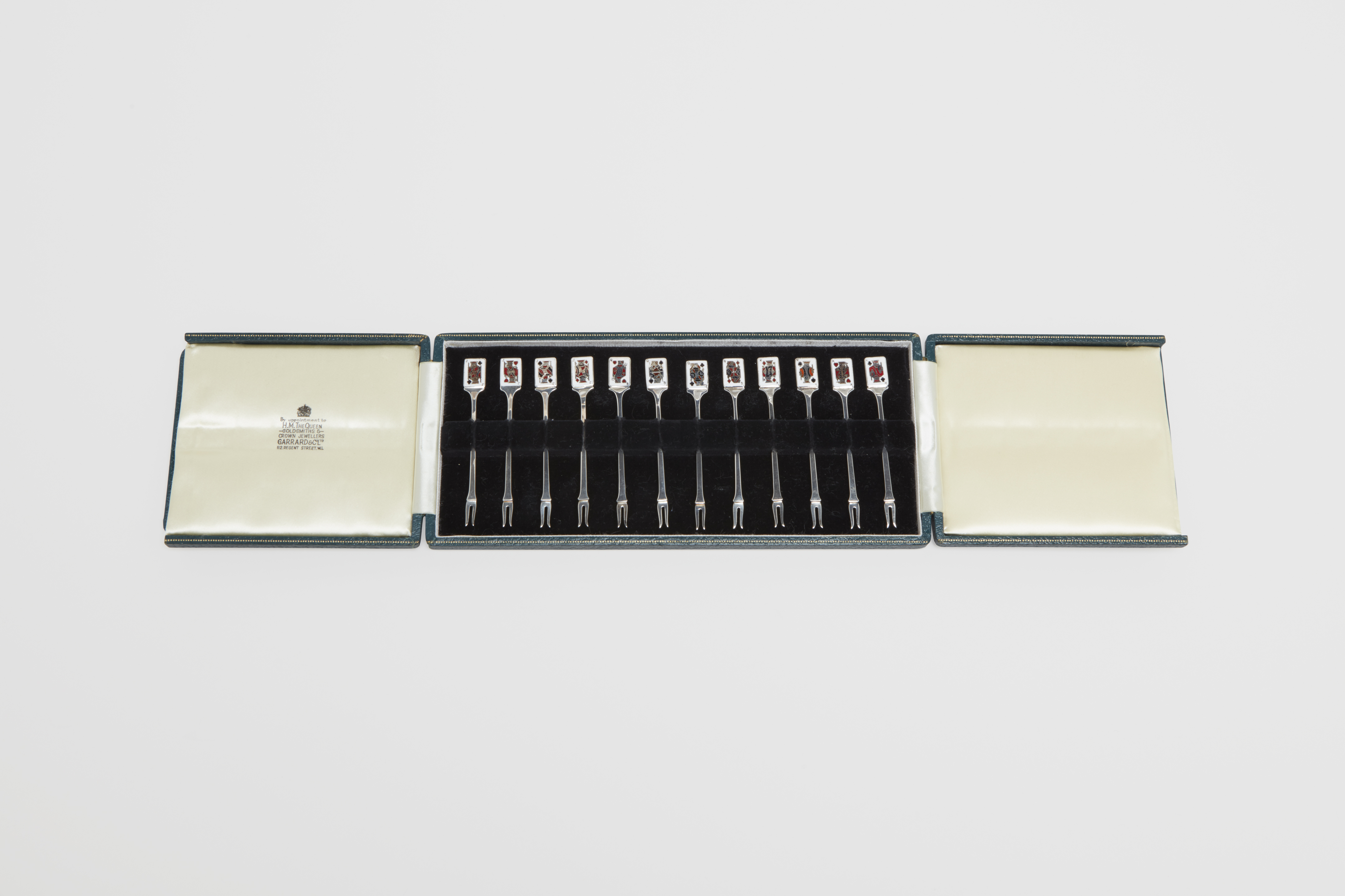 A SET OF TWELVE ENGLISH SILVER AND ENAMEL COCKTAIL PICKS | GARRARD & CO ...