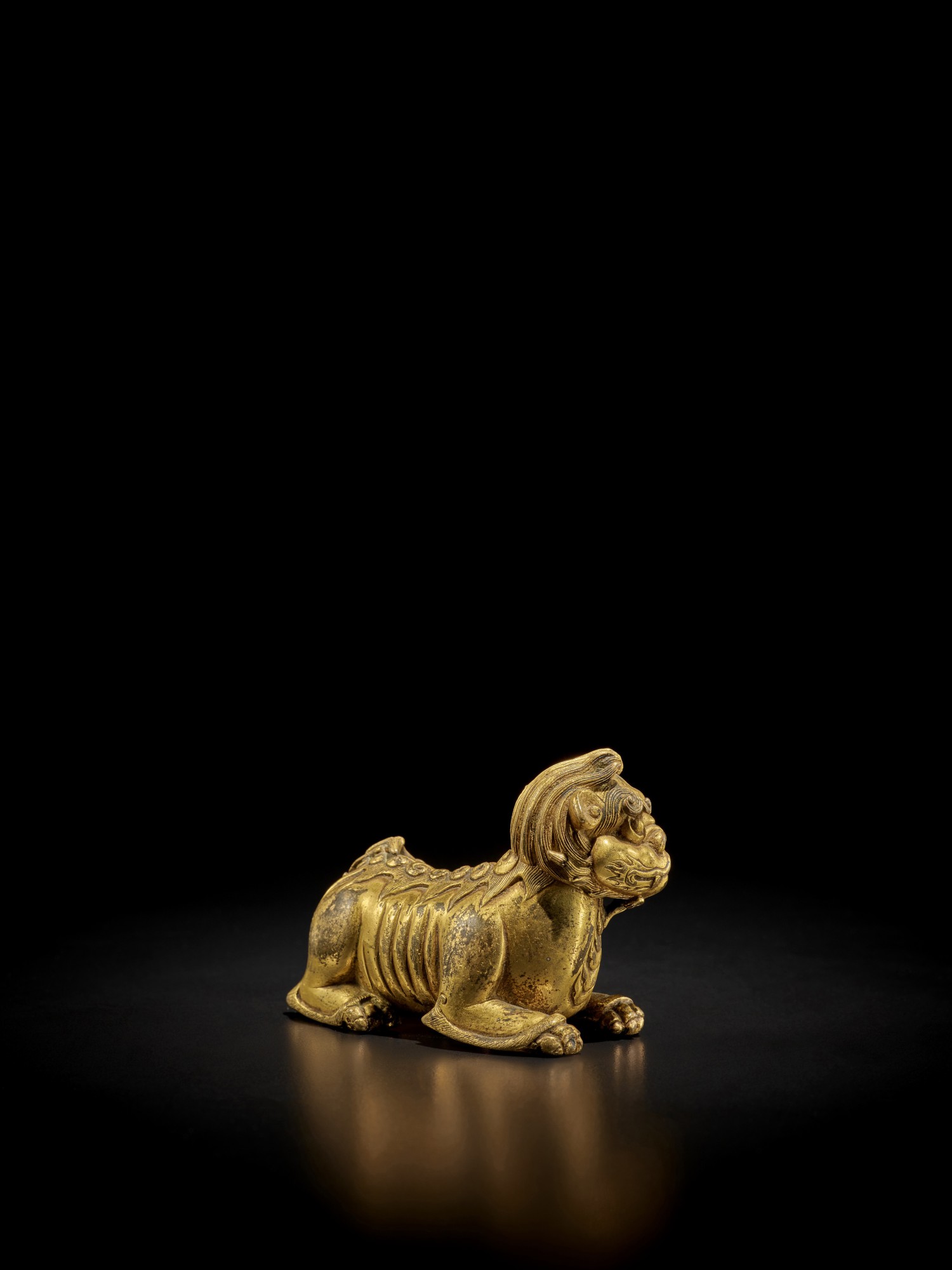 A gilt-bronze 'mythical beast' weight, Ming dynasty | 明 銅鎏金瑞獸形鎮 ...