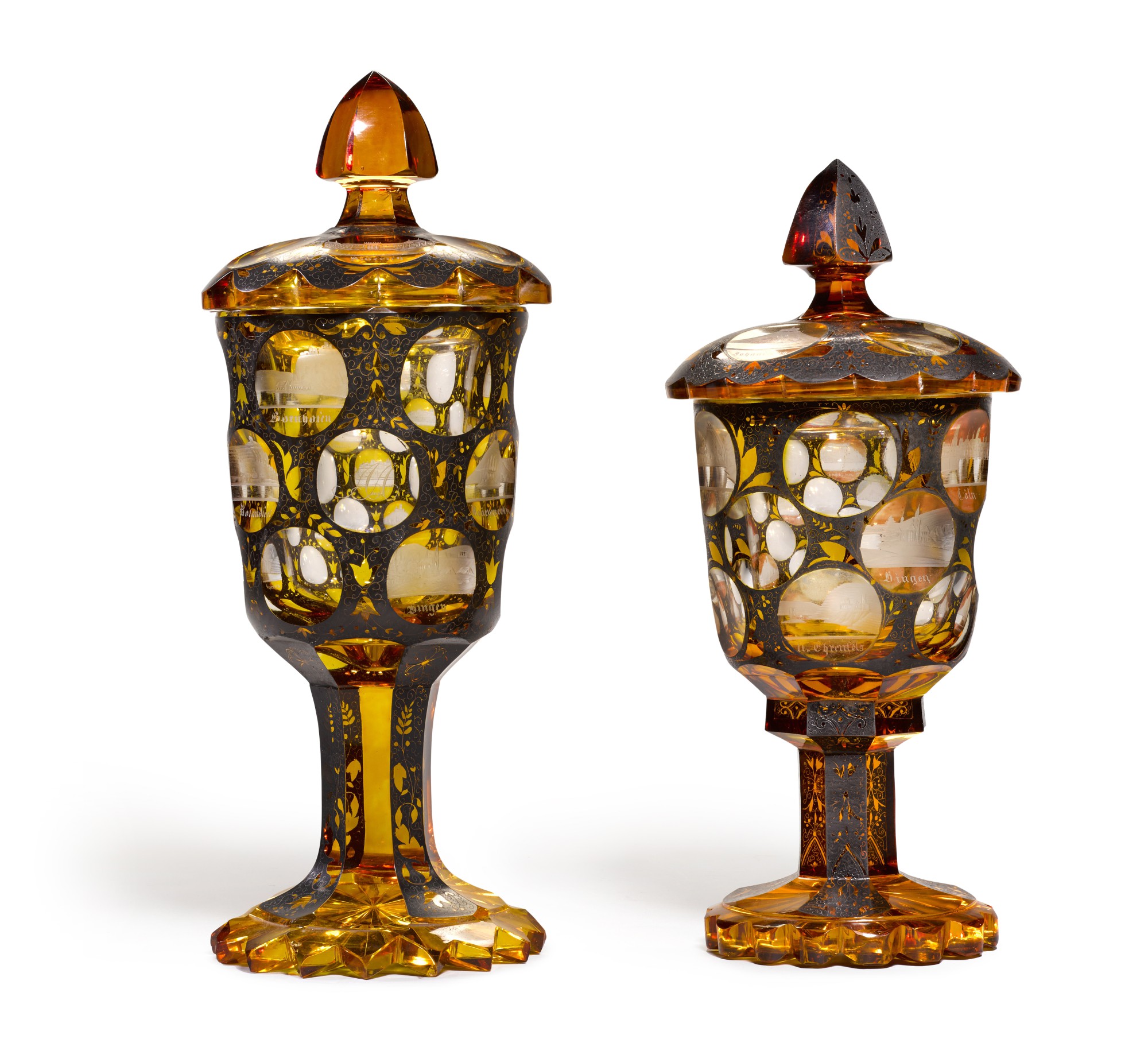 Two Bohemian amber-stained engraved and enamelled glass goblets and ...