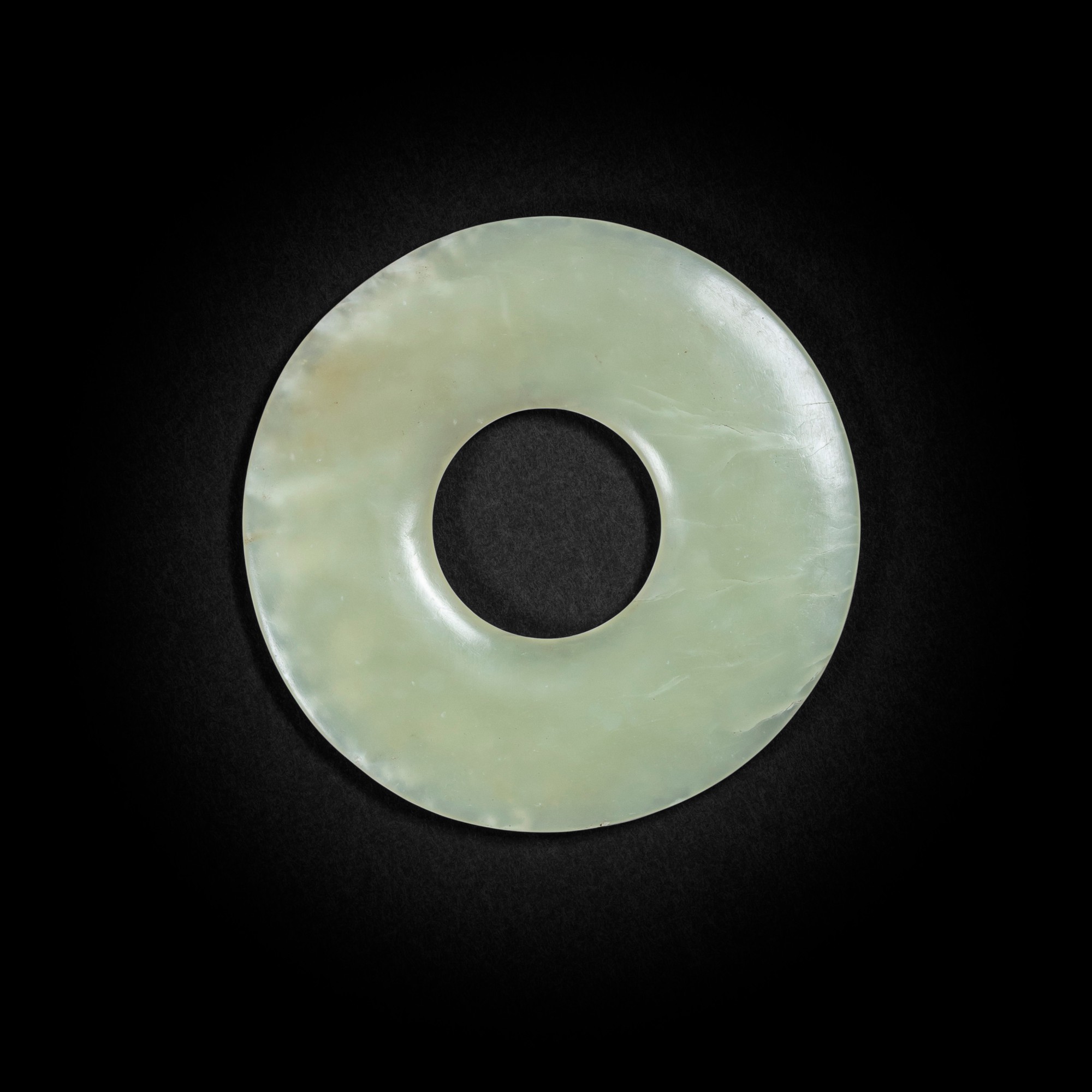 A superb celadon jade disc, bi Neolithic period, Hongshan culture ...