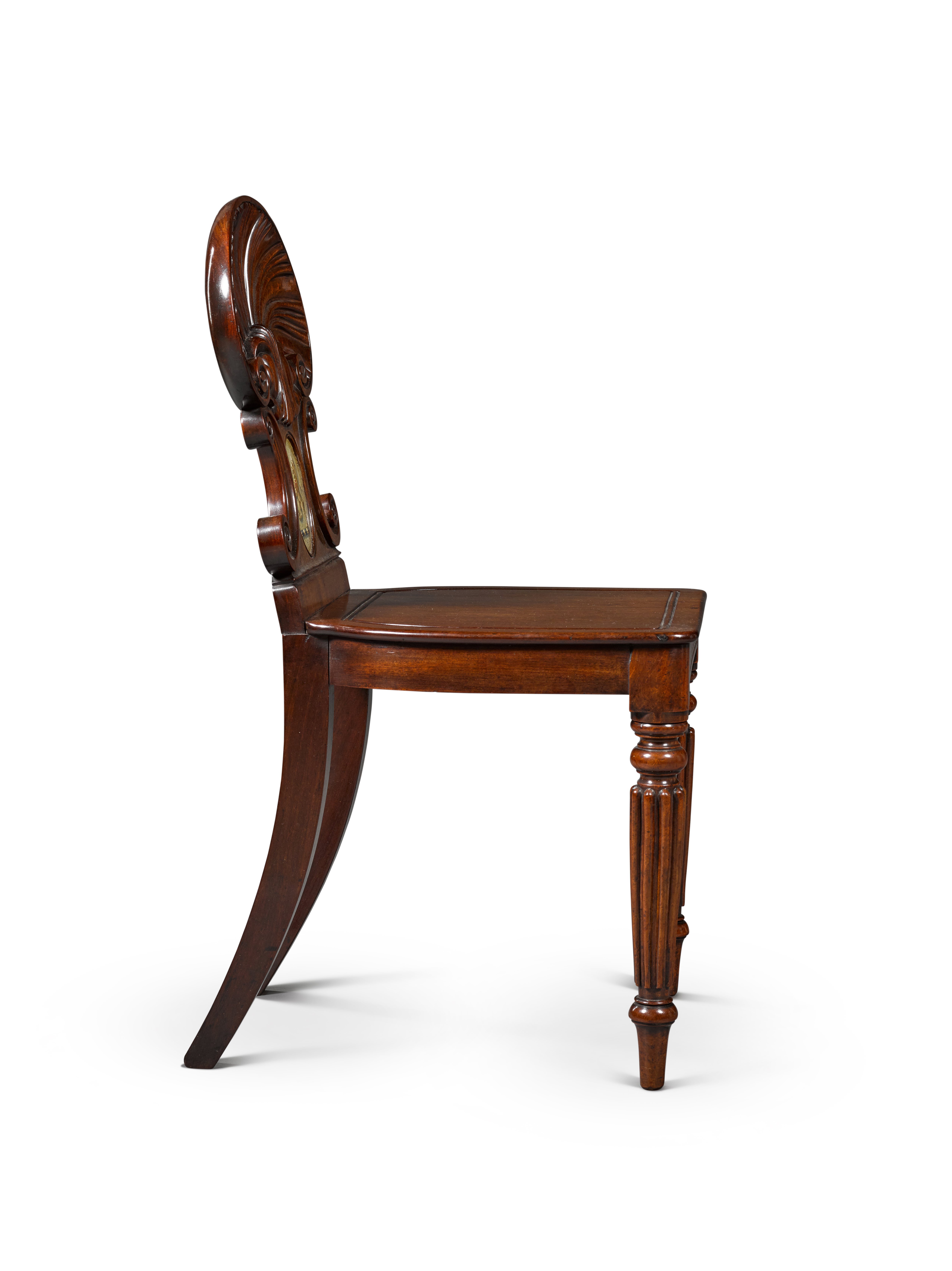 A pair of late Regency mahogany hall chairs, circa 1825, attributed to ...