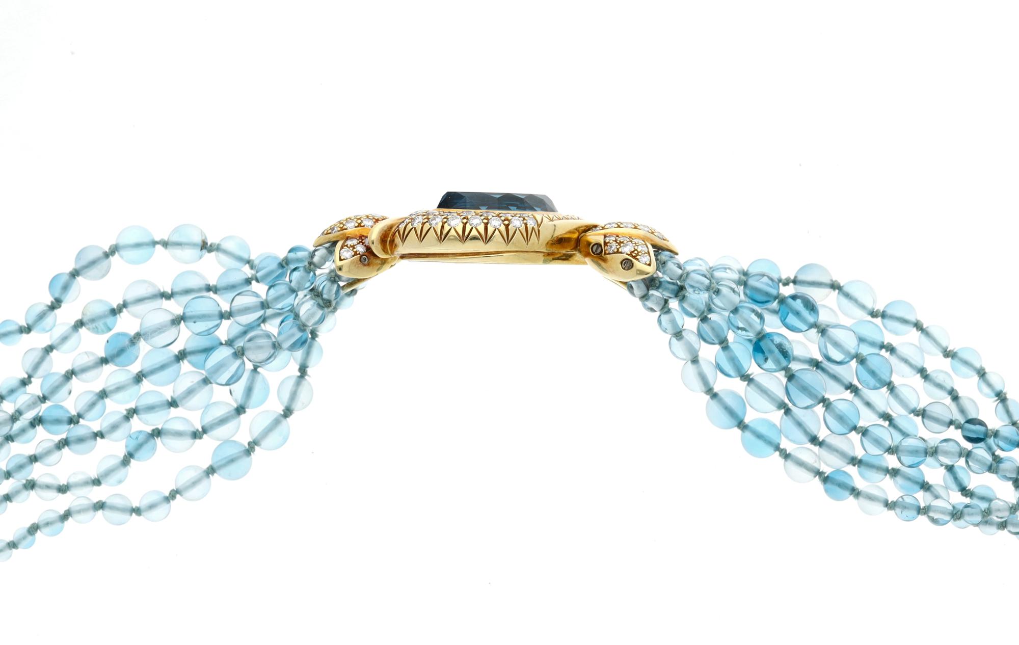 A yellow gold and diamond-set watch with blue topaz beads bracelet ...