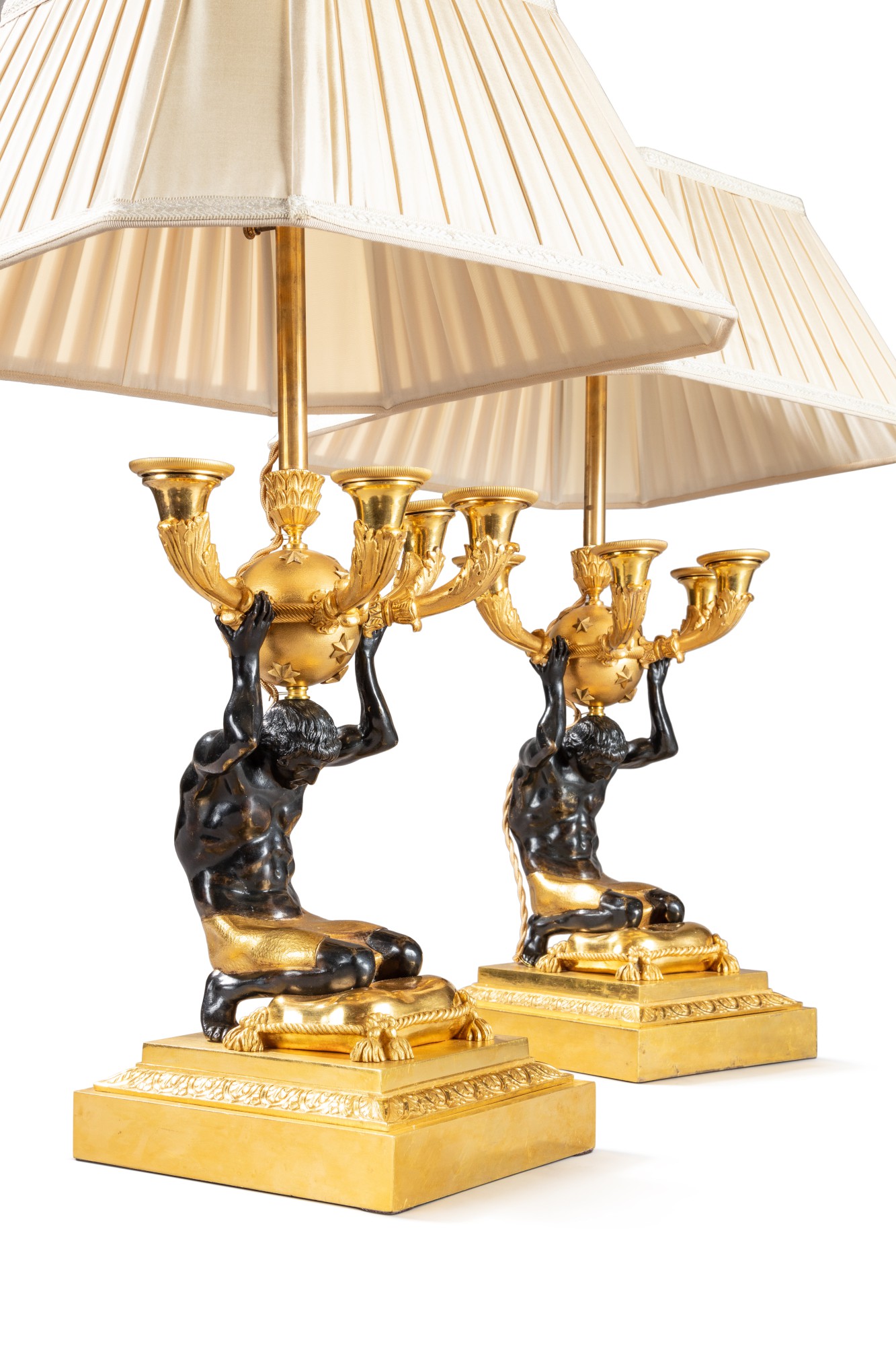 A pair of gilt and patinated bronze four-light candelabra, 19th century ...