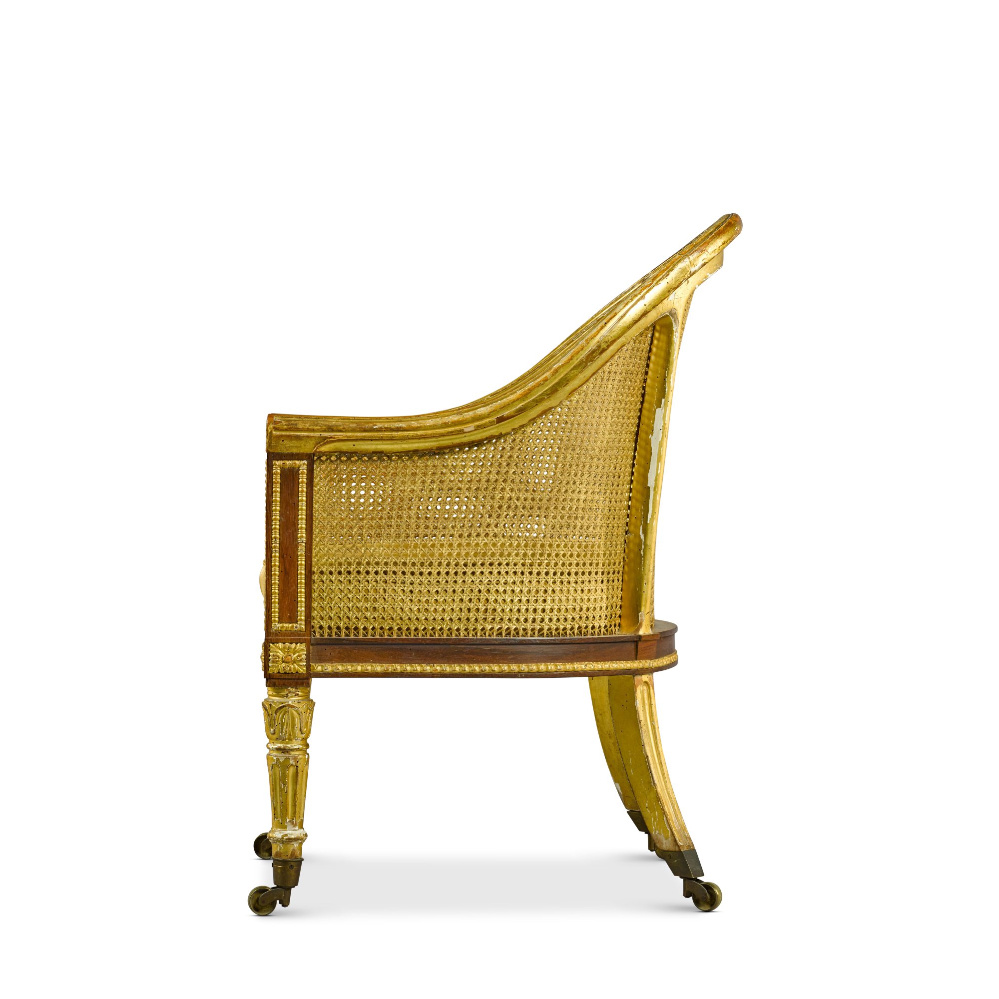 A pair of Regency simulated rosewood and parcel-gilt caned tub chairs ...
