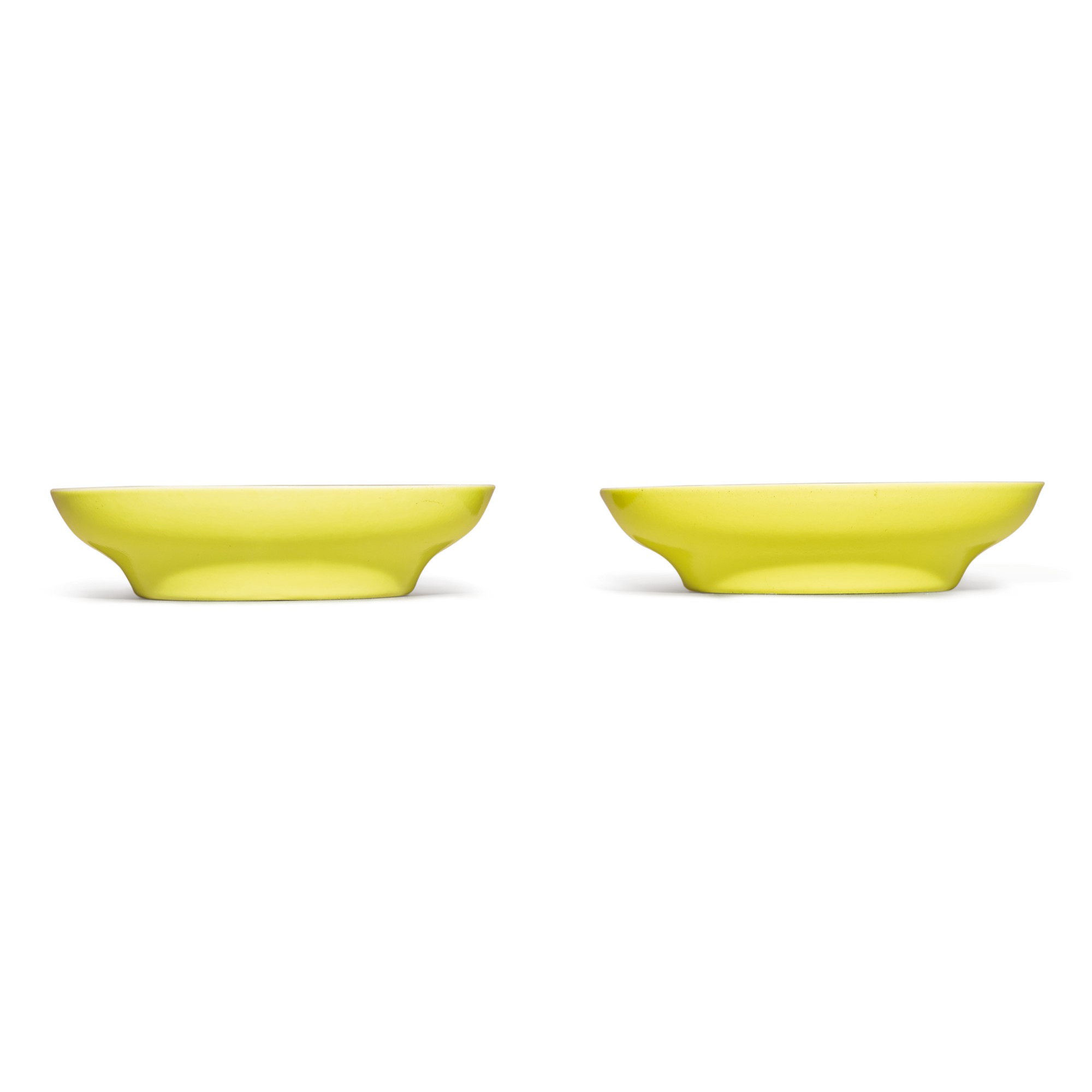A fine pair of yellow-glazed ogee-form dishes, Qianlong seal marks and ...