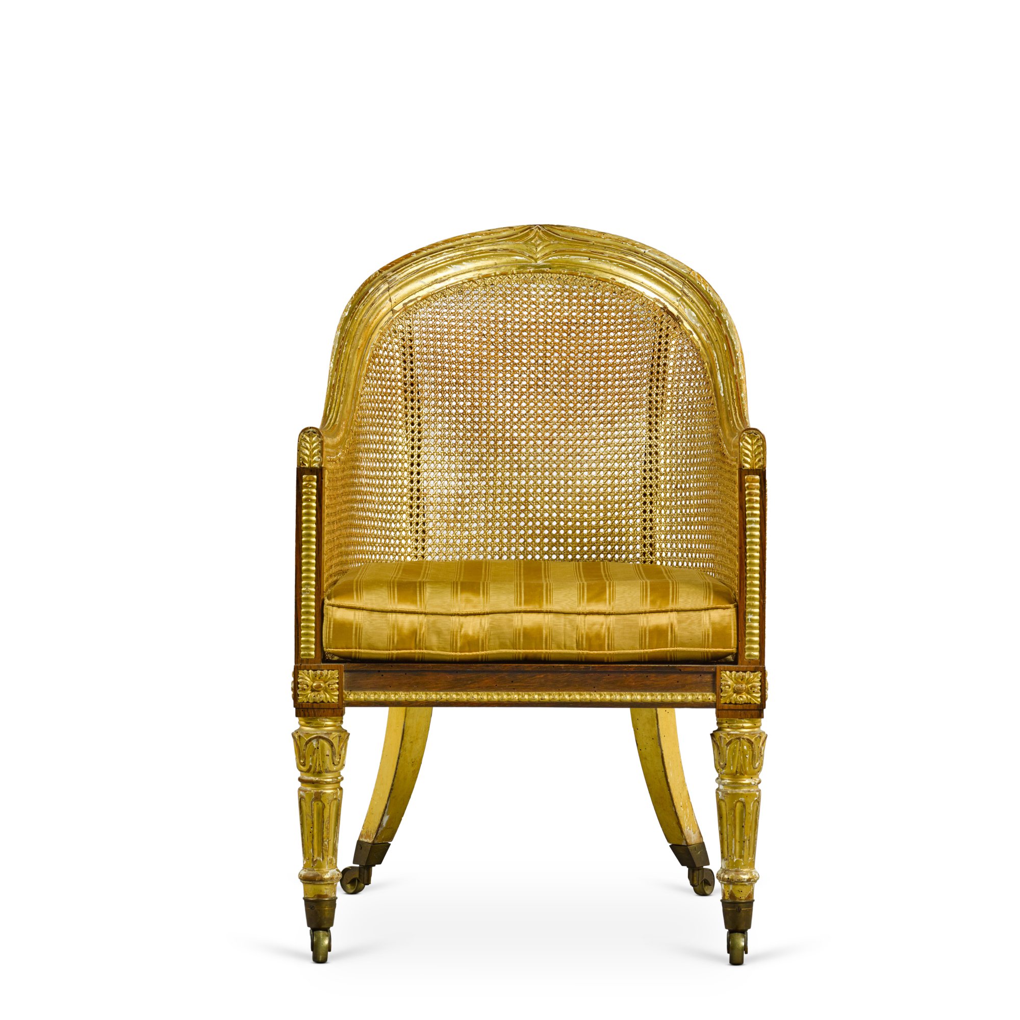 A pair of Regency simulated rosewood and parcel-gilt caned tub chairs ...