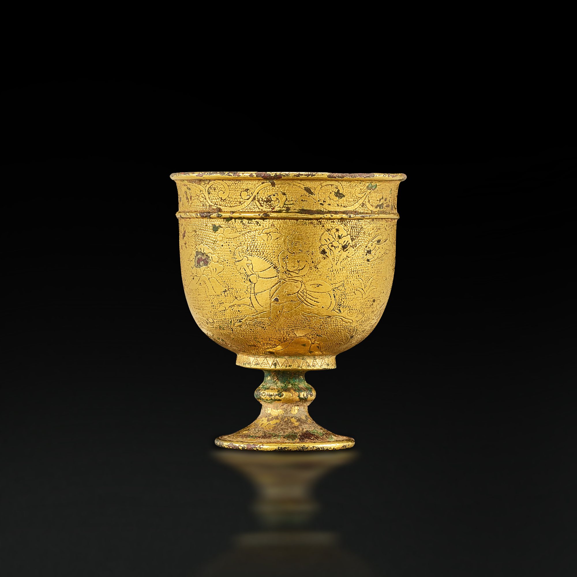 A small finely engraved gilt-bronze 'hunting' stem cup, Tang dynasty ...