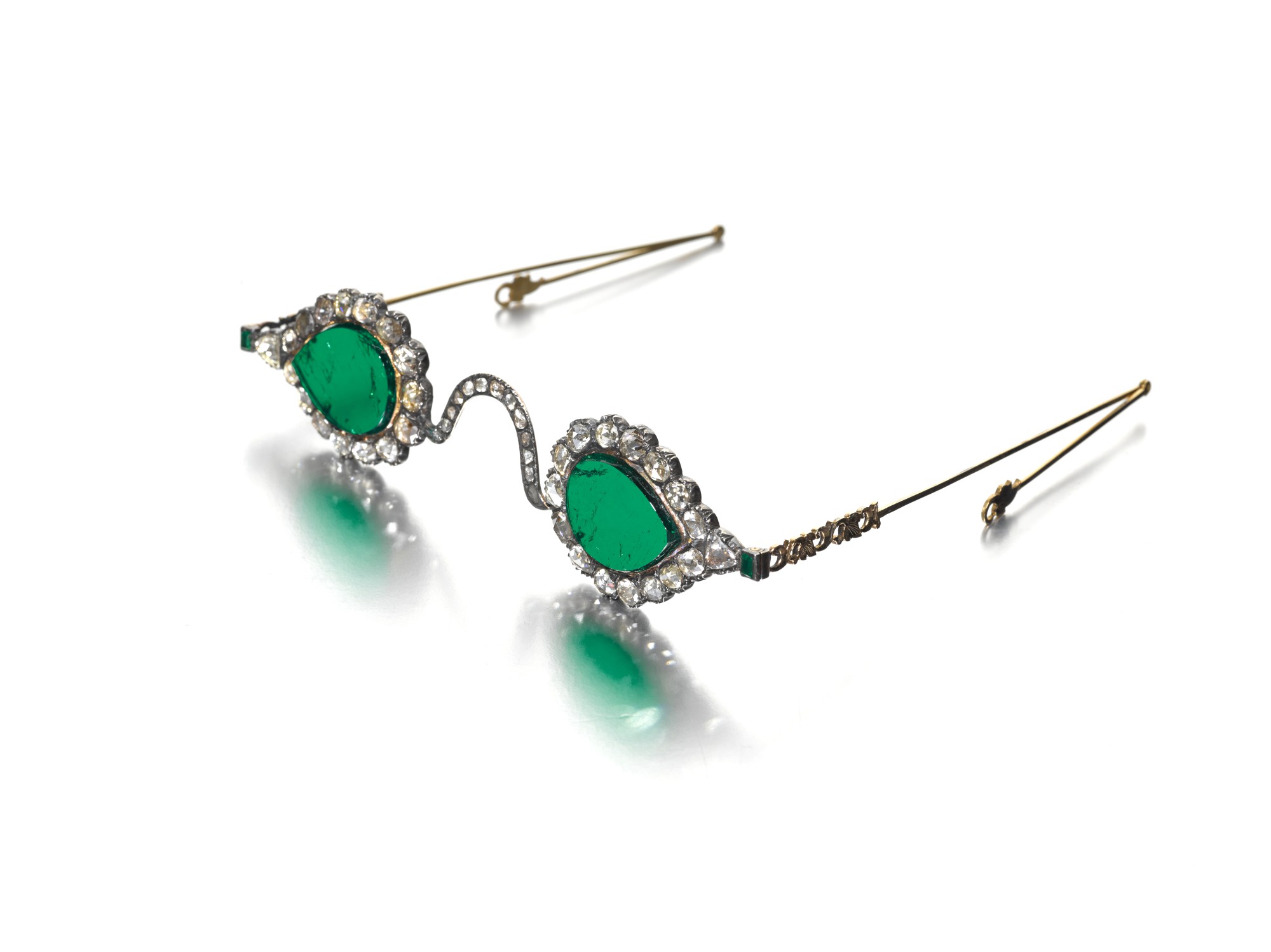 A pair of Mughal spectacles set with emerald lenses, in diamond-mounted ...