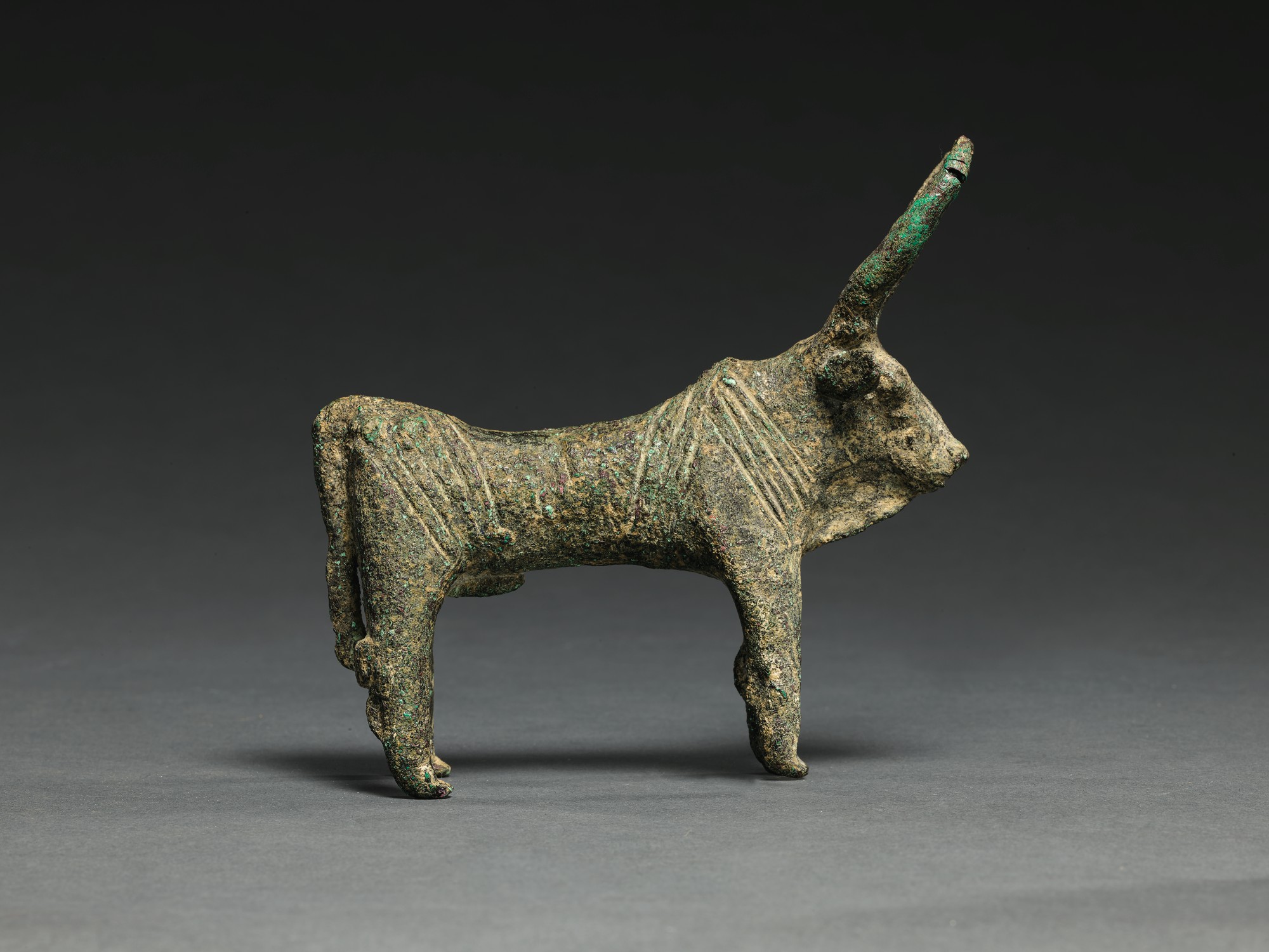 A BRONZE FIGURE OF A BULL, PROBABLY CRETAN, CIRCA LATE 2ND MILLENNIUM B ...