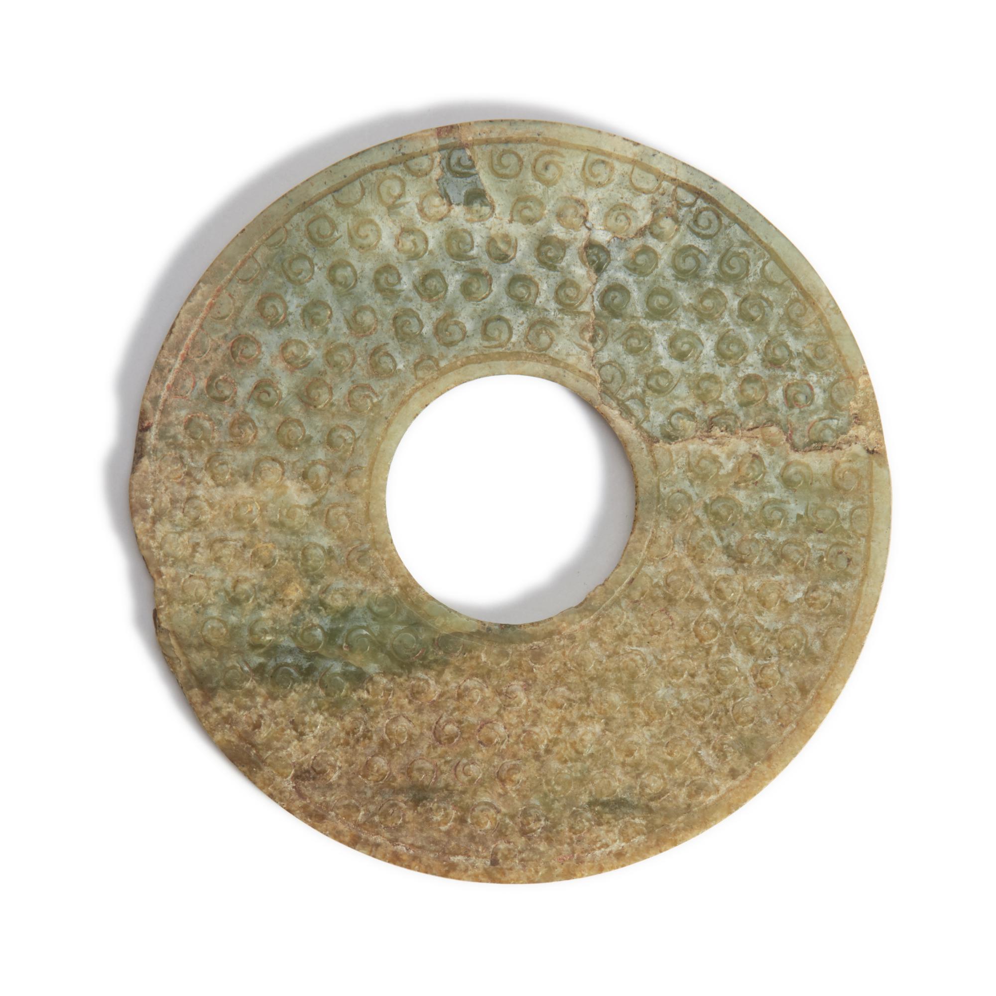 A green and russet jade bi disc, Warring States period / Western Han ...
