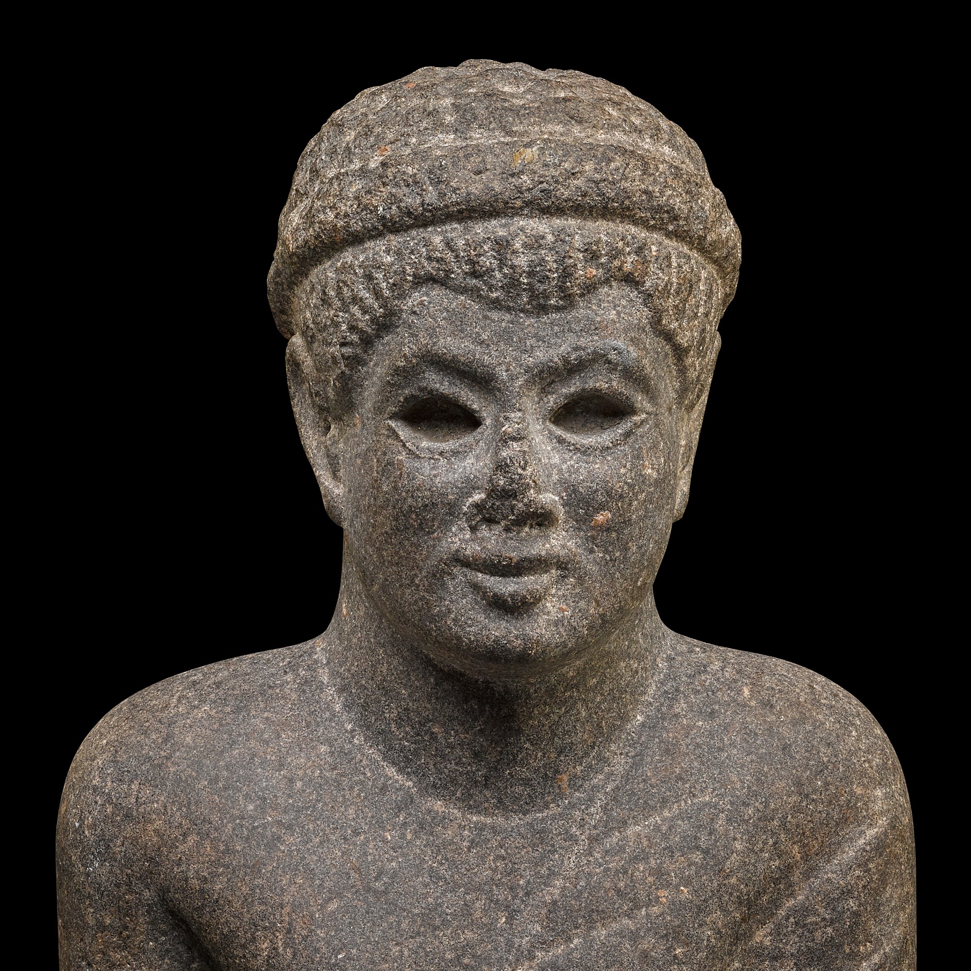 AN EGYPTIAN GRANITE FIGURE OF PAKHOM, GOVERNOR OF DENDERA, LATE ...