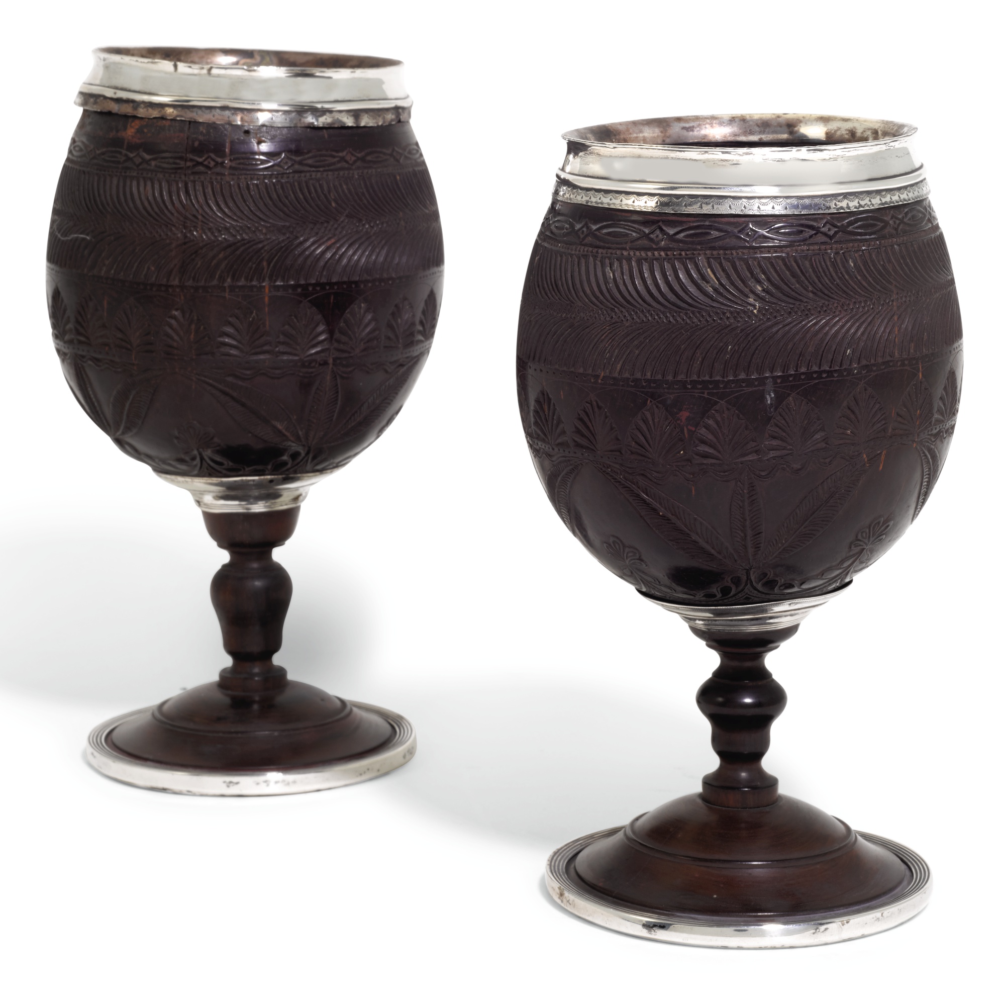 A PAIR OF GEORGE III SILVER MOUNTED CARVED COCONUT CUPS, THE MOUNTS ...