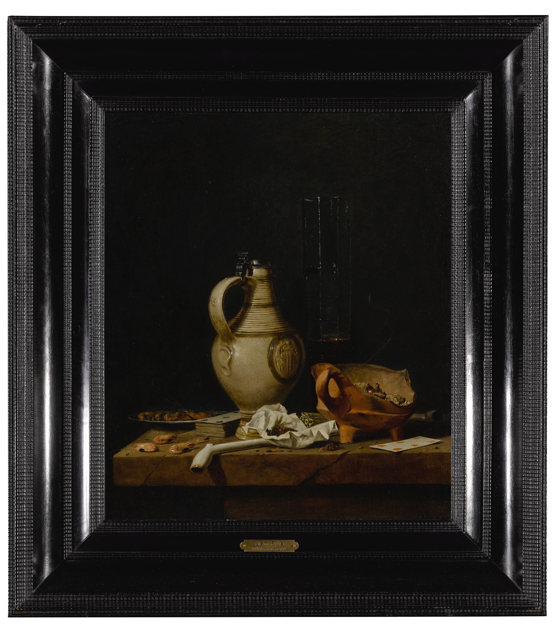 A still life with a stoneware jug, a glass of beer, playing cards and ...