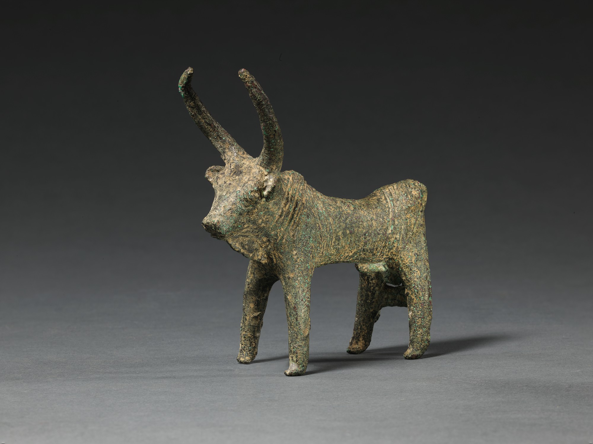 A BRONZE FIGURE OF A BULL, PROBABLY CRETAN, CIRCA LATE 2ND MILLENNIUM B ...