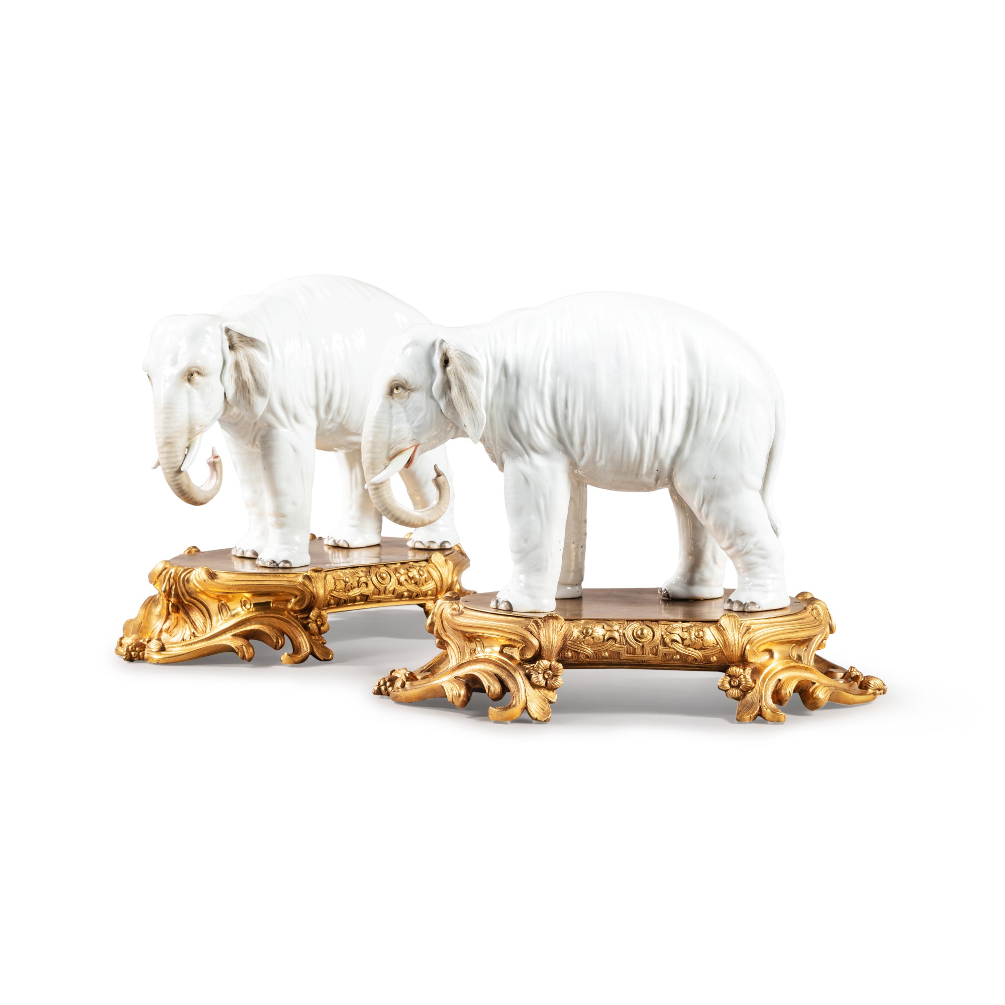 A pair of gilt-bronze mounted porcelain models of elephants, the ...