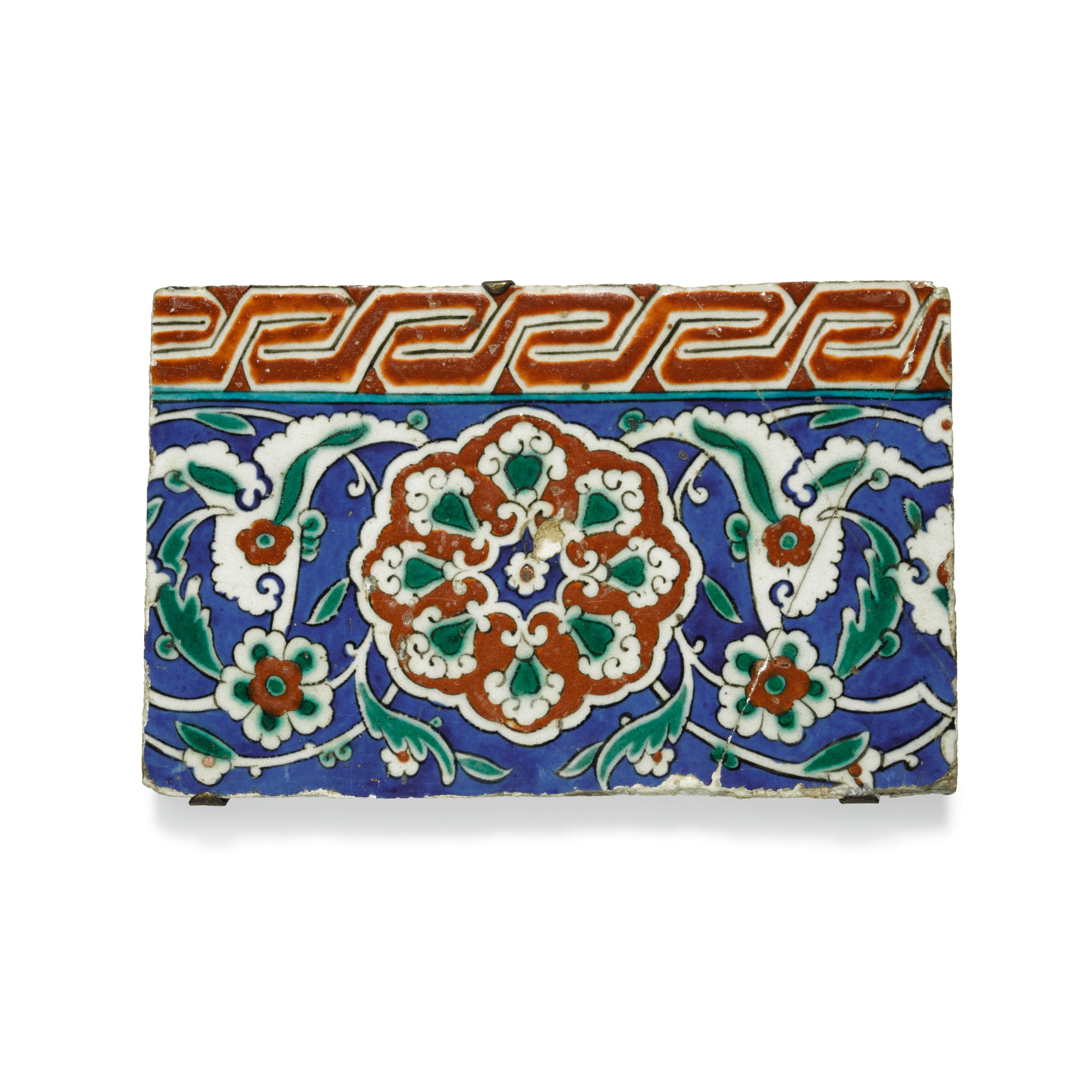 AN IZNIK POLYCHROME POTTERY BORDER TILE WITH COMPOSITE FLOWERHEAD AND ...