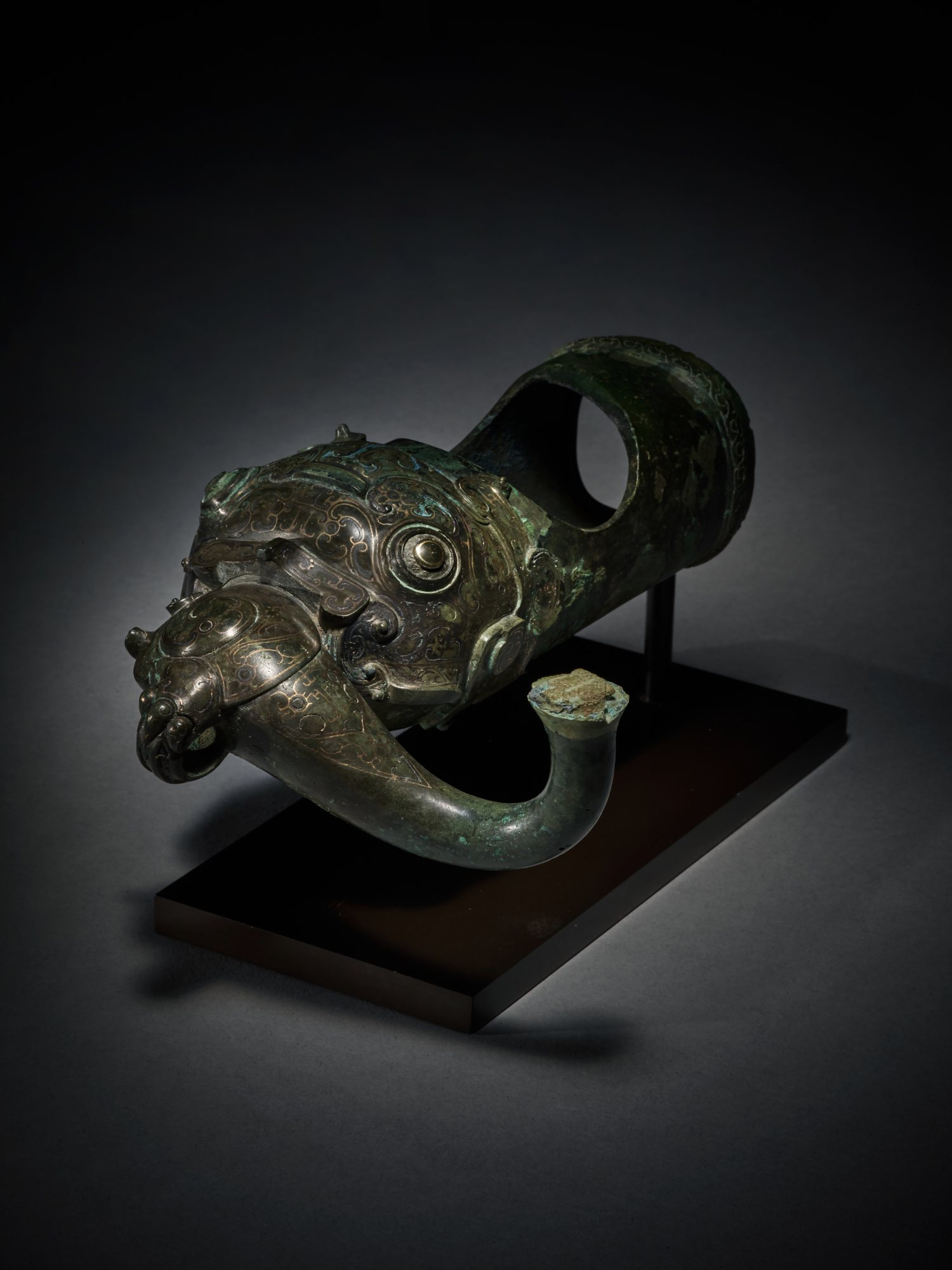 An exceptionally rare silver and gold-inlaid zoomorphic fitting Eastern ...