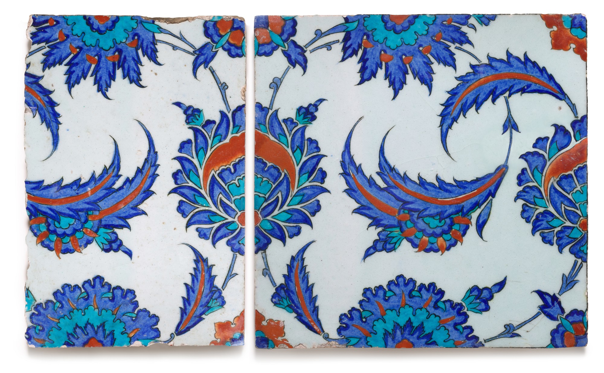 Two Iznik polychrome pottery tiles with lotus palmette and saz leaves ...