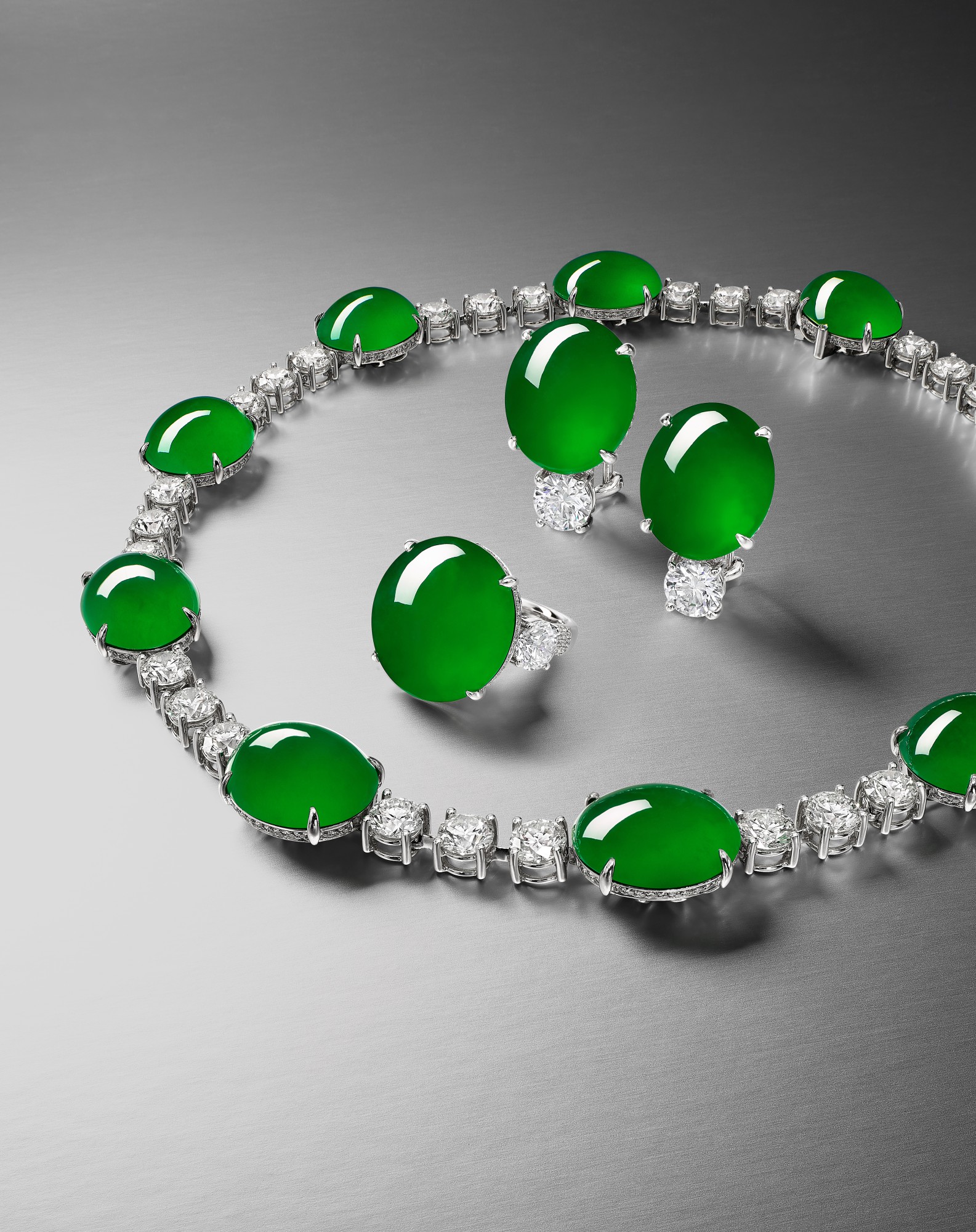 A Highly Rare and Important 'Imperial Green' Jadeite and Diamond Parure ...