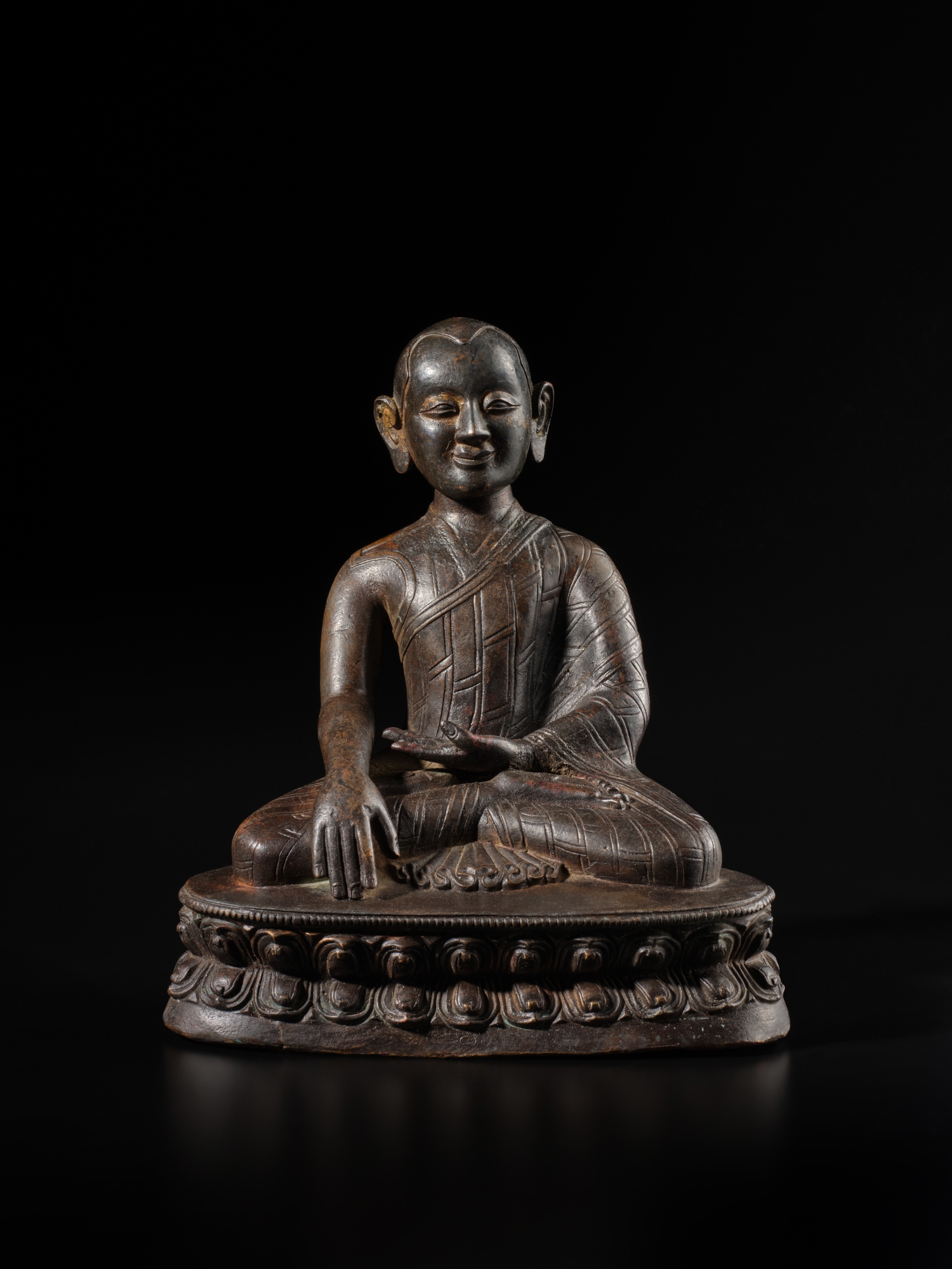 A large copper alloy figure of a lama, Tibet, circa 14th century ...