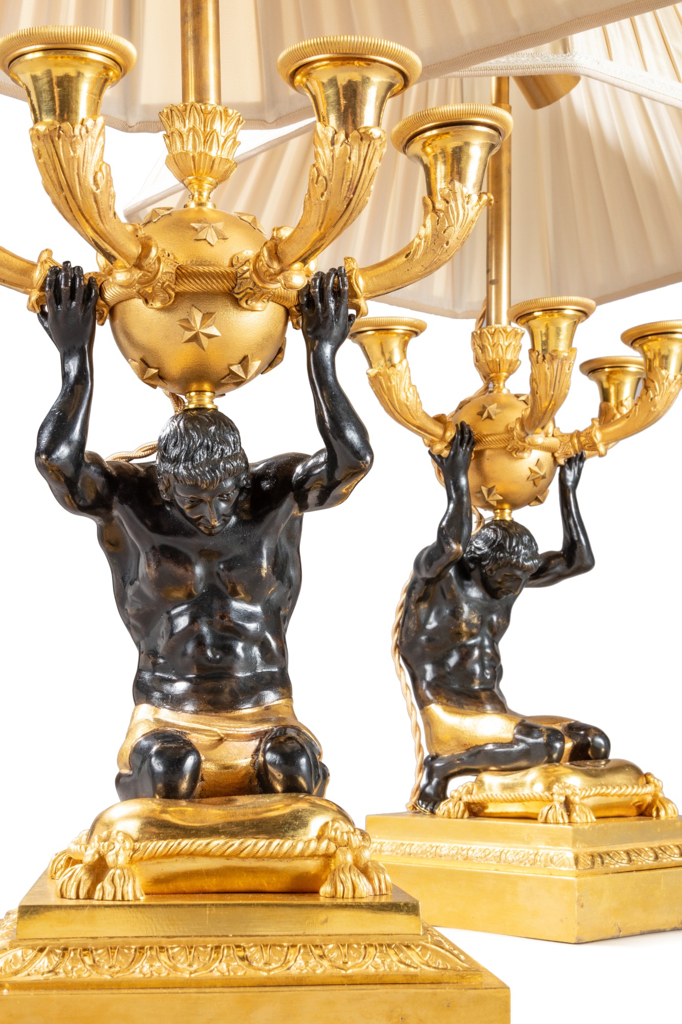 A pair of gilt and patinated bronze four-light candelabra, 19th century ...