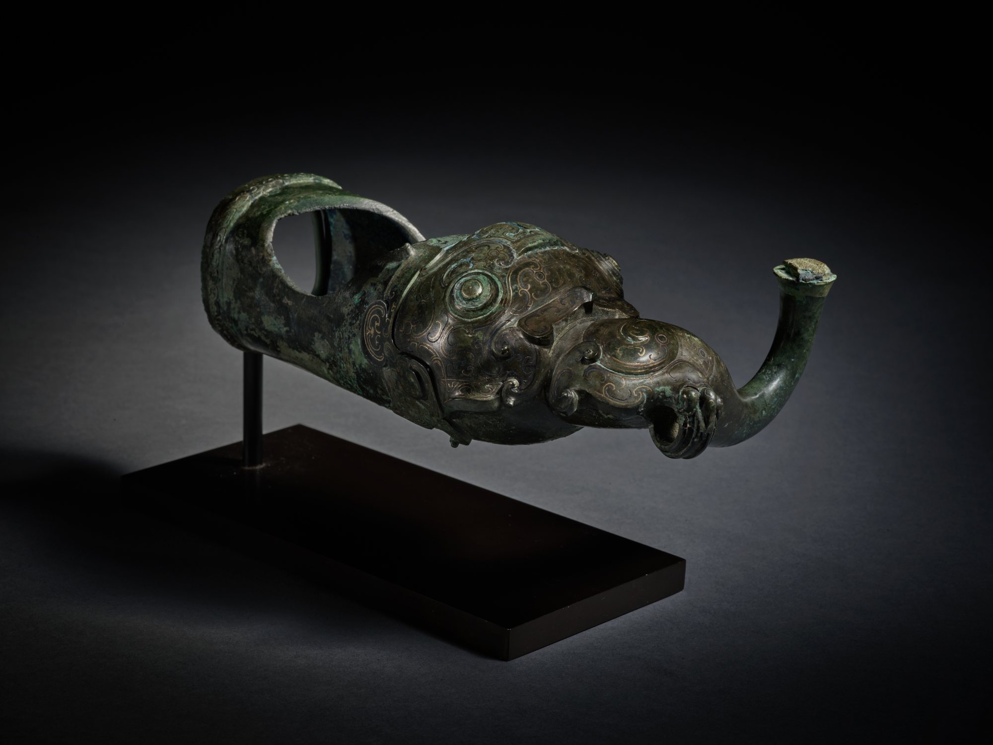 An exceptionally rare silver and gold-inlaid zoomorphic fitting Eastern ...