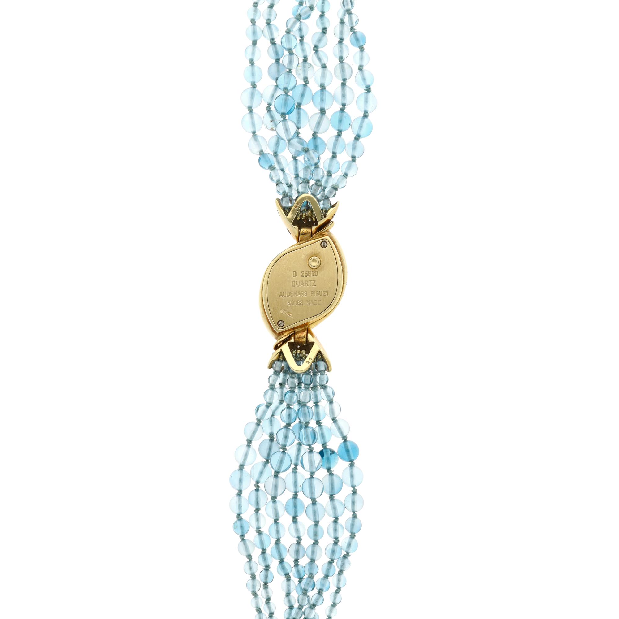 A yellow gold and diamond-set watch with blue topaz beads bracelet ...