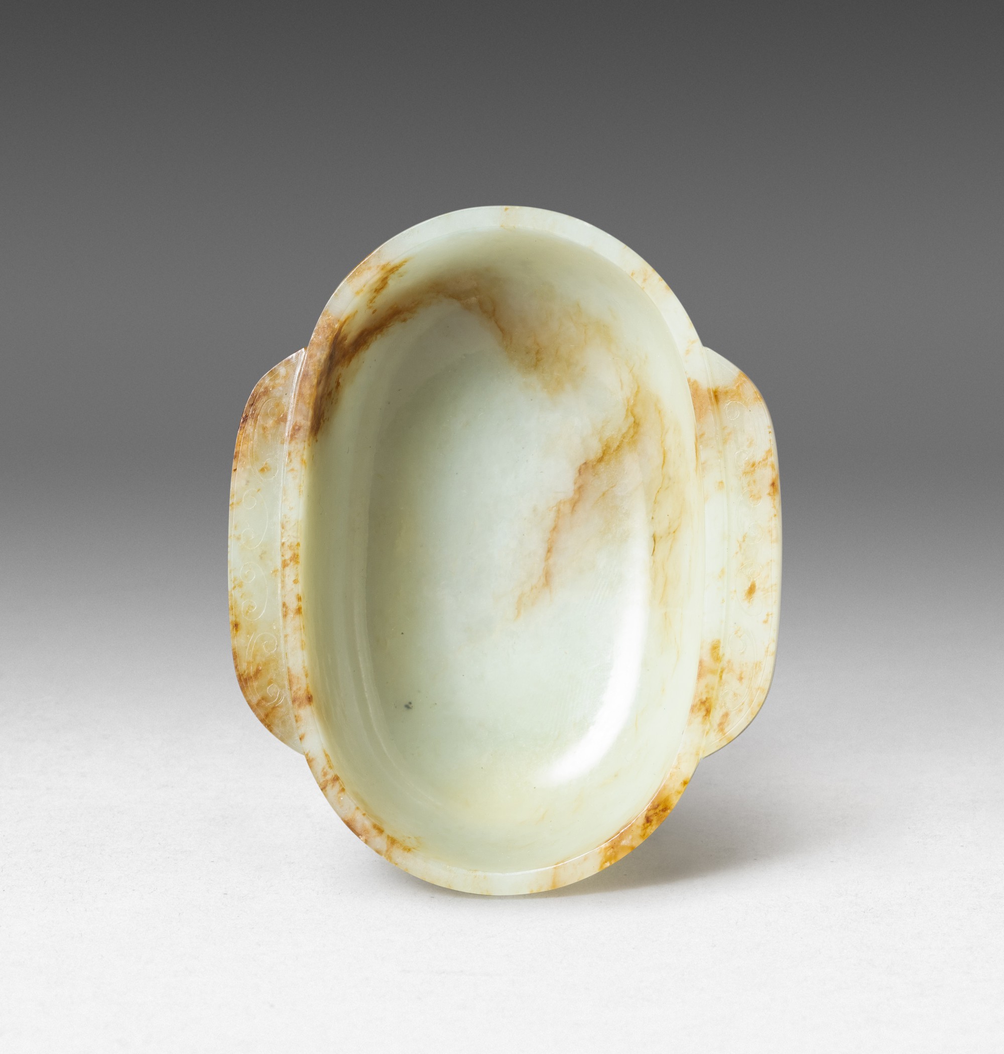 A Han-style celadon and russet jade ear-cup, probably Qing dynasty ...