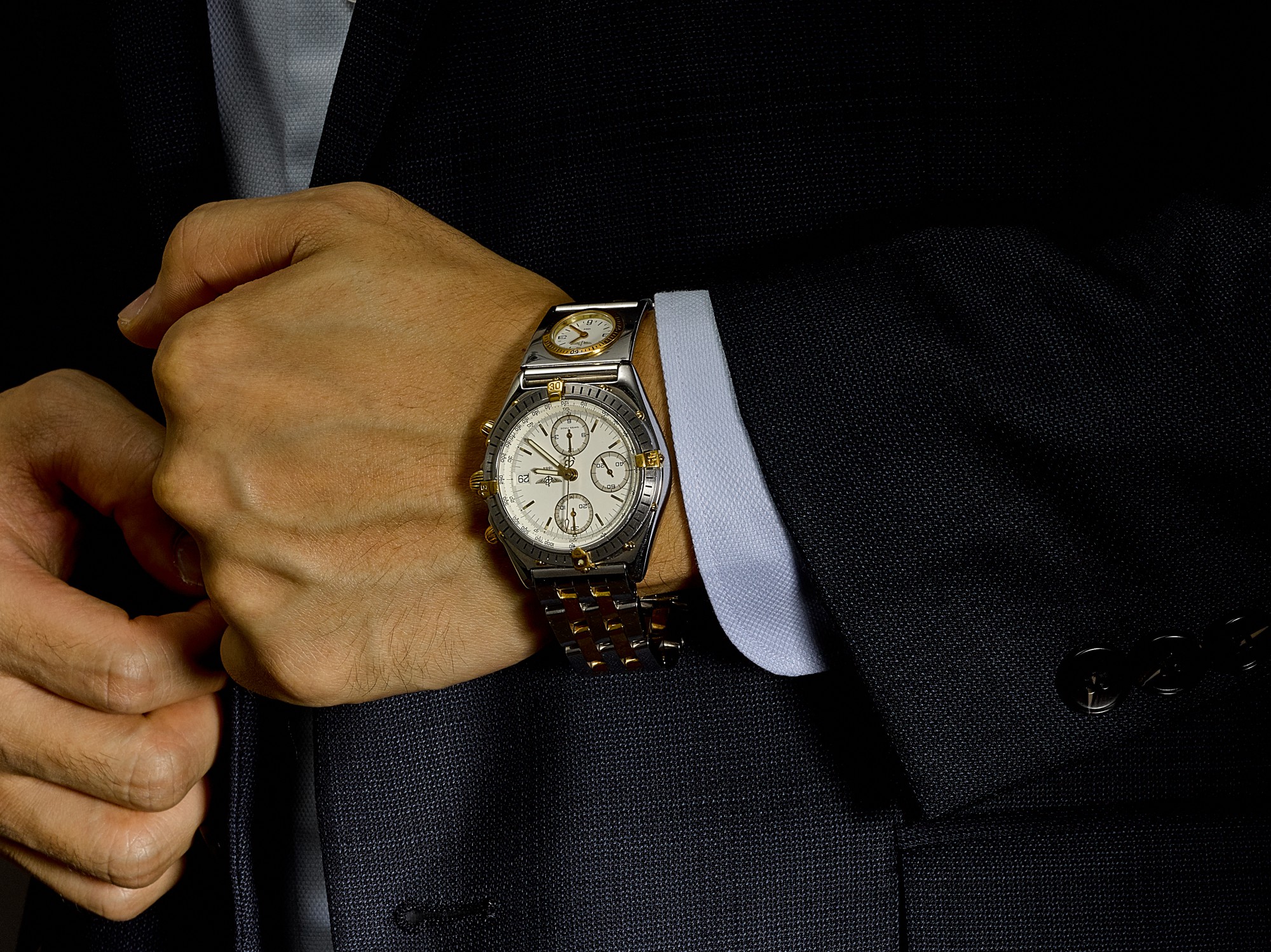 BREITLING | A STAINLESS STEEL AND YELLOW GOLD DUAL TIME ZONE ...