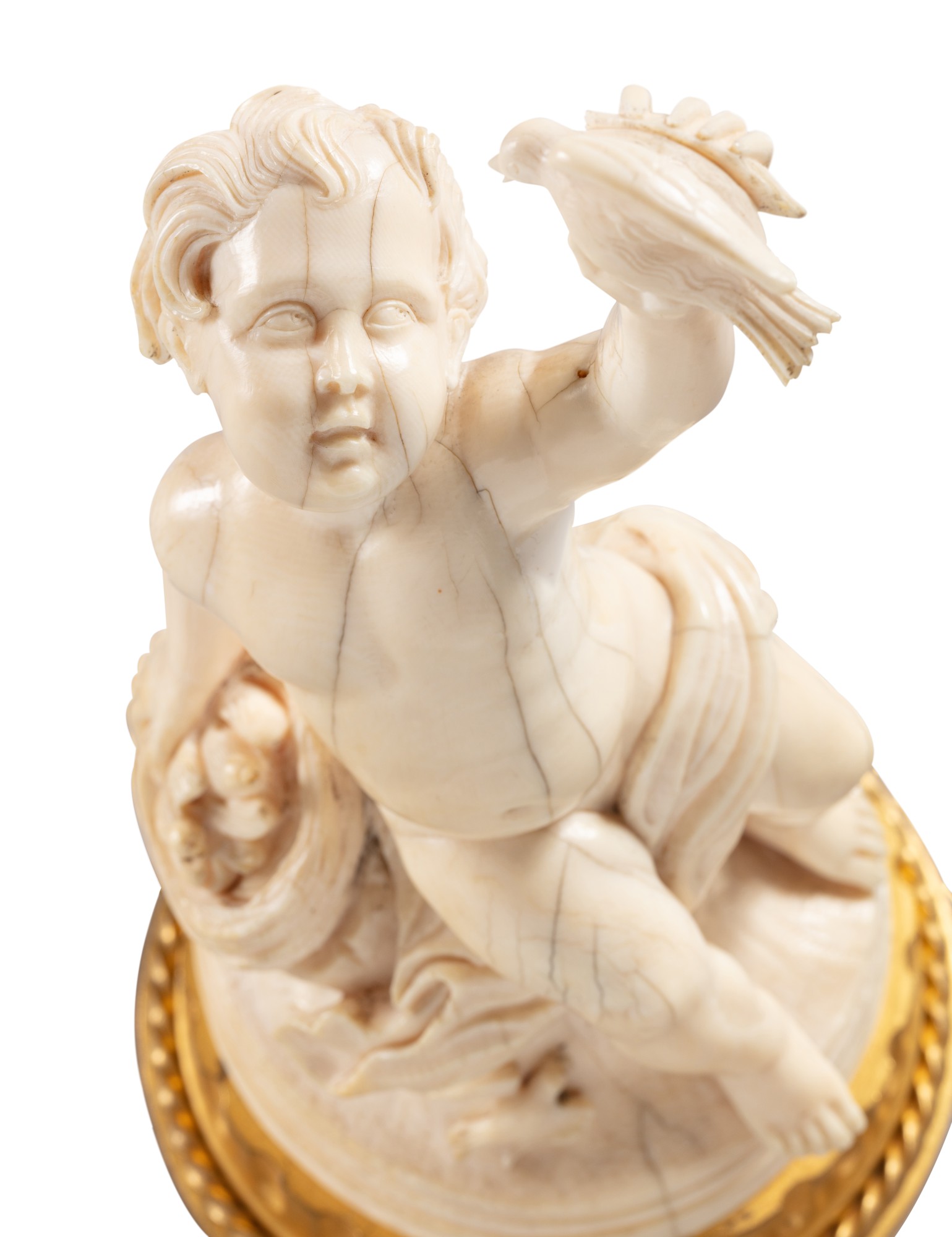 A French ivory seated Putto holding a bird, Late 18th / early 19th ...